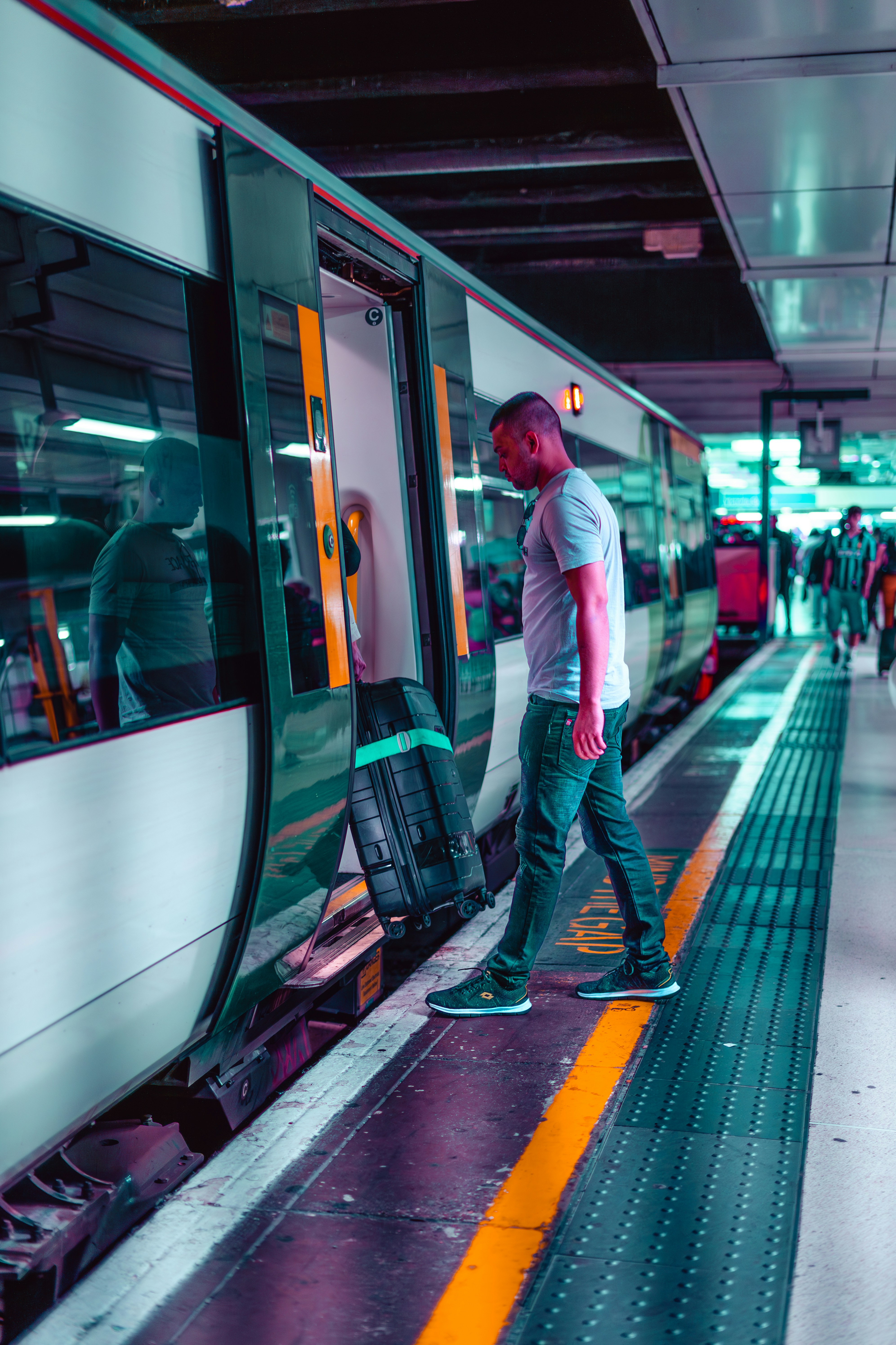 A man standing on a platform next to a train photo – Free Adult Image ...