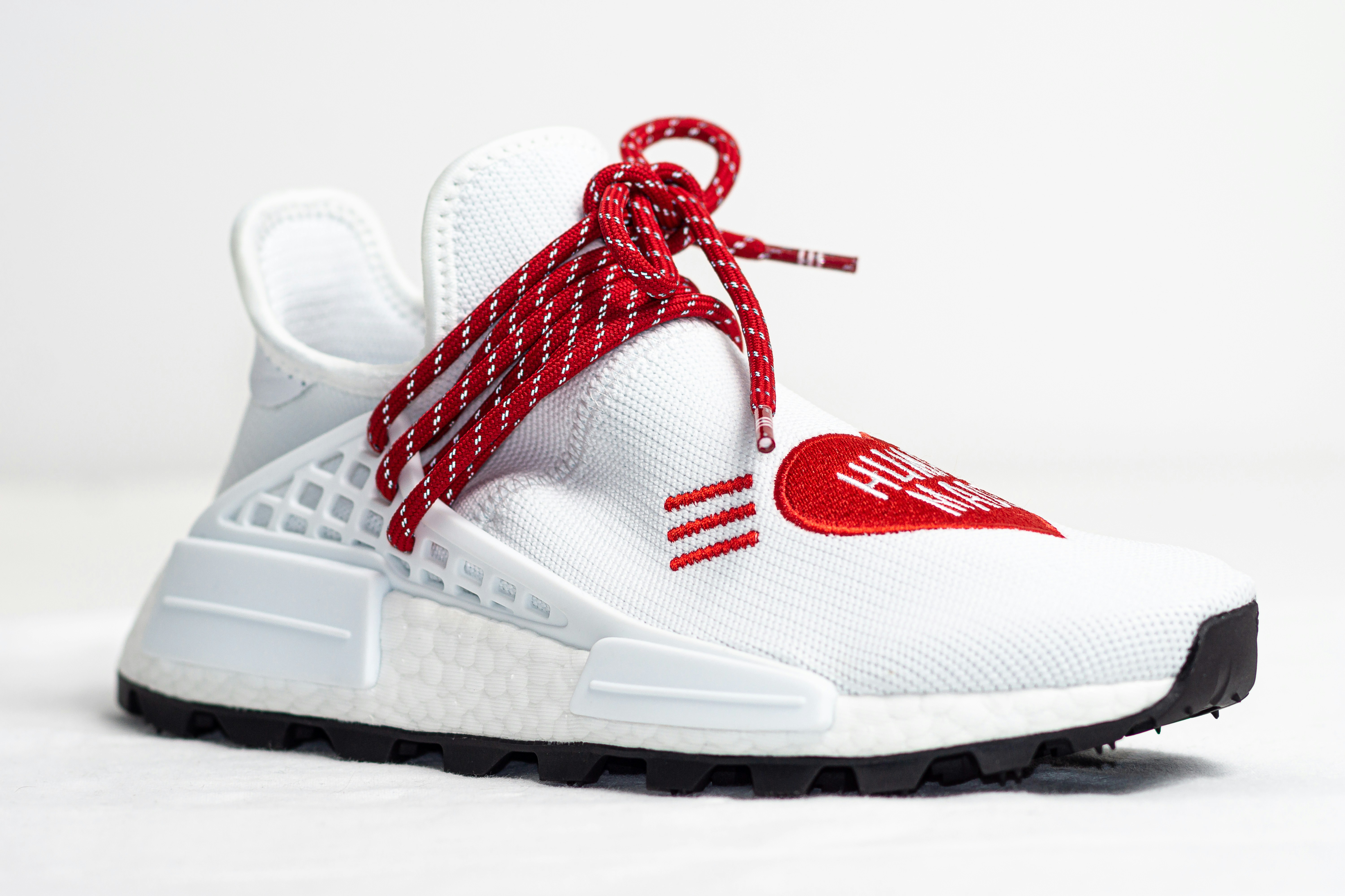 A pair of white sneakers with red and black laces photo – Free ...