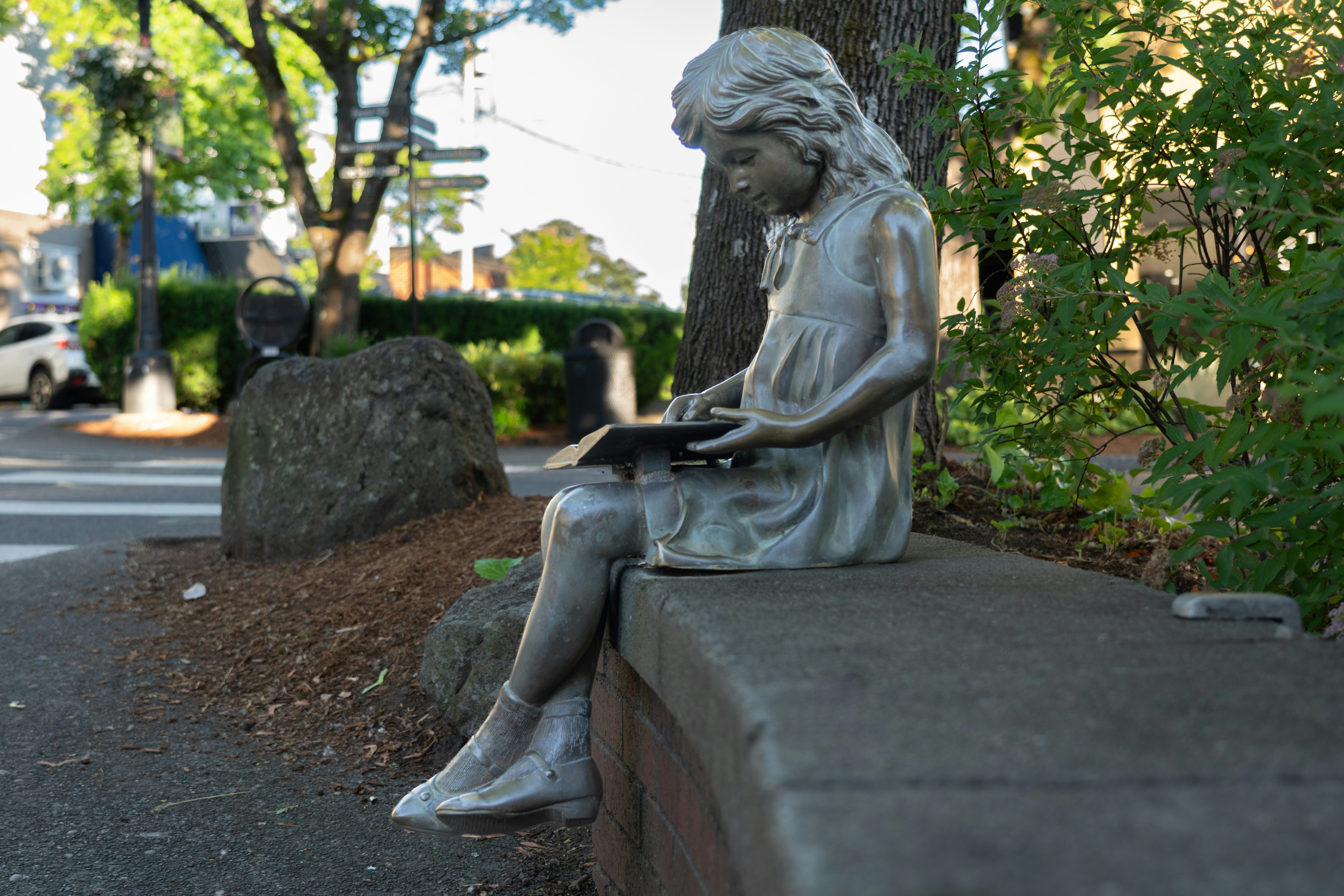 Quiet Marble Reader Beneath the Park's Green Canopy