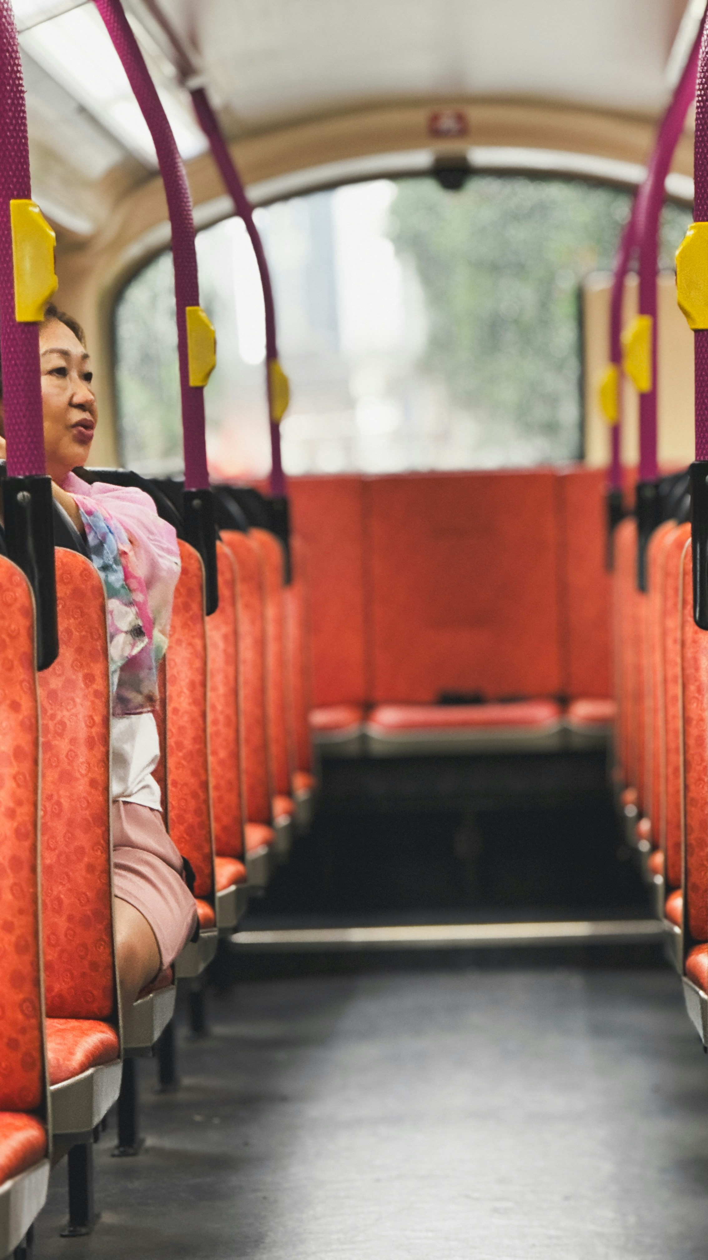 Bus Ride Quiet: A Woman in Orange Seats
