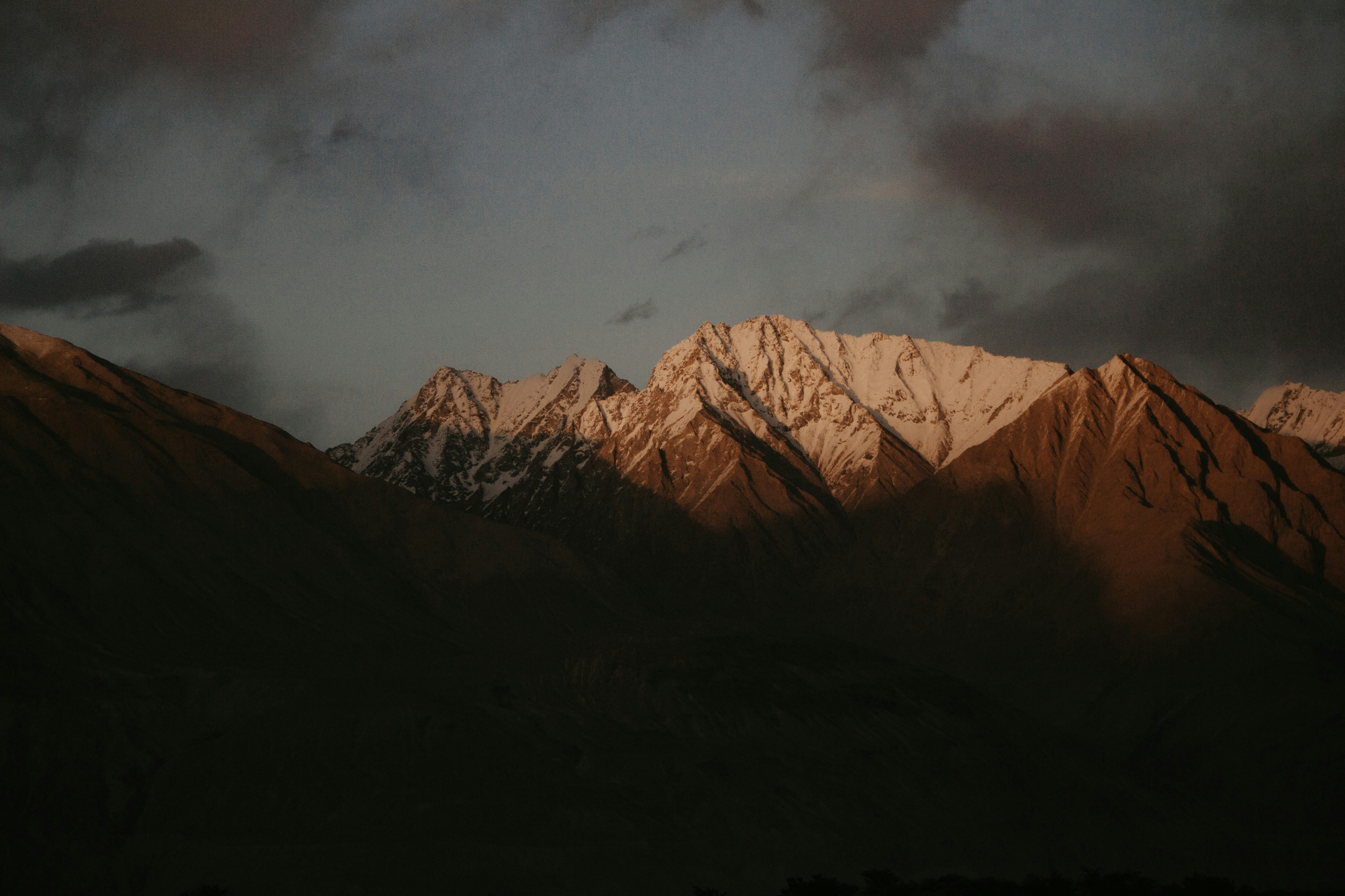Gold-Washed Summit: Snow-Capped Ridge at Twilight