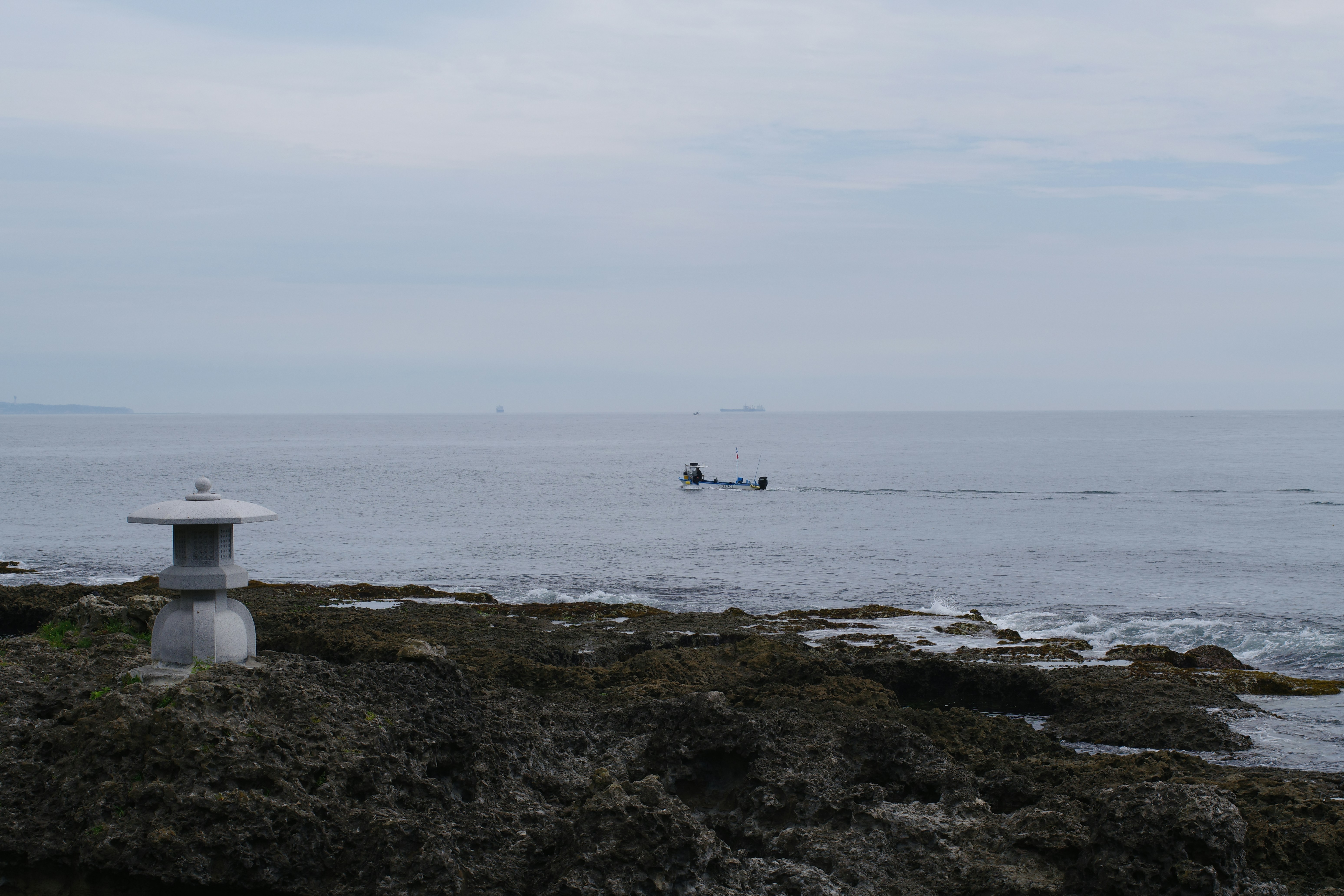 Beacon by the Sea: A Quiet Shore Under an Overcast Sky