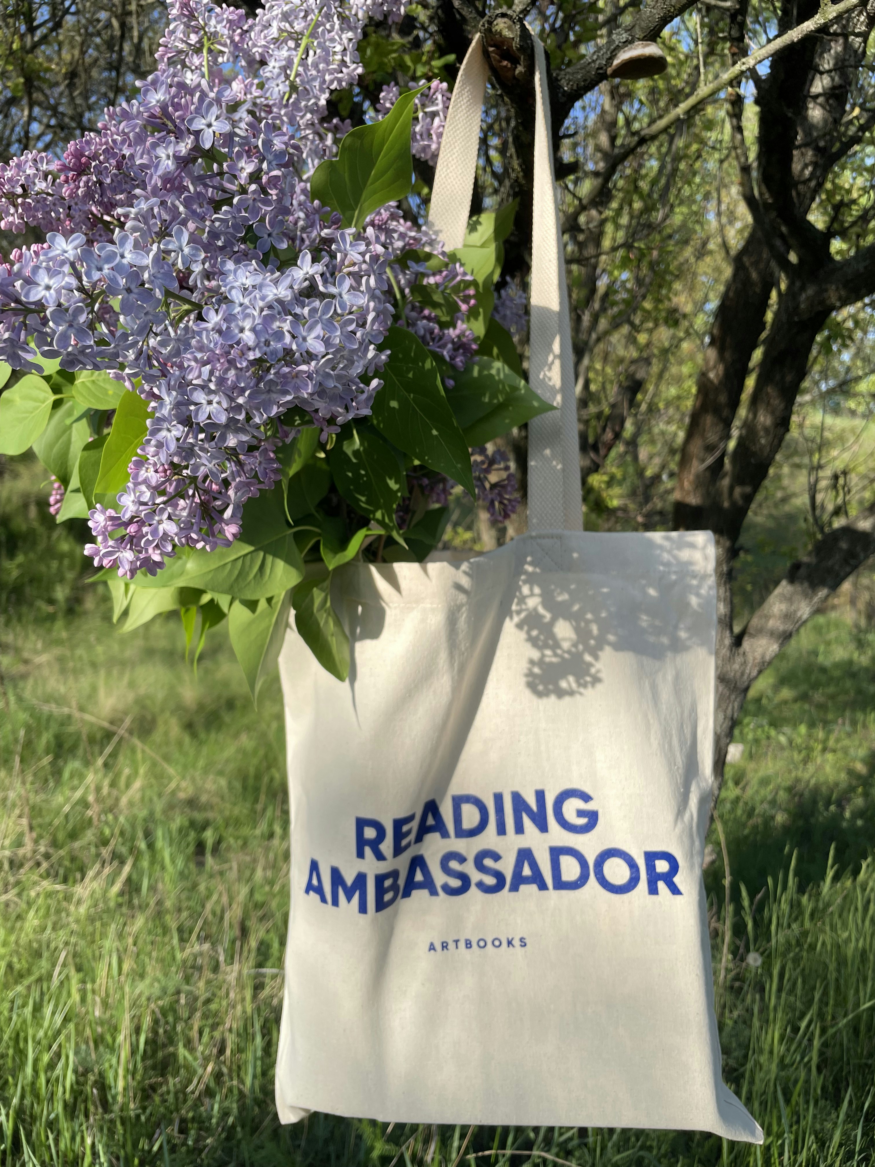 Lilac Bouquet in a Canvas Tote: A Sunlit Field Portrait of a Reading Ambassador