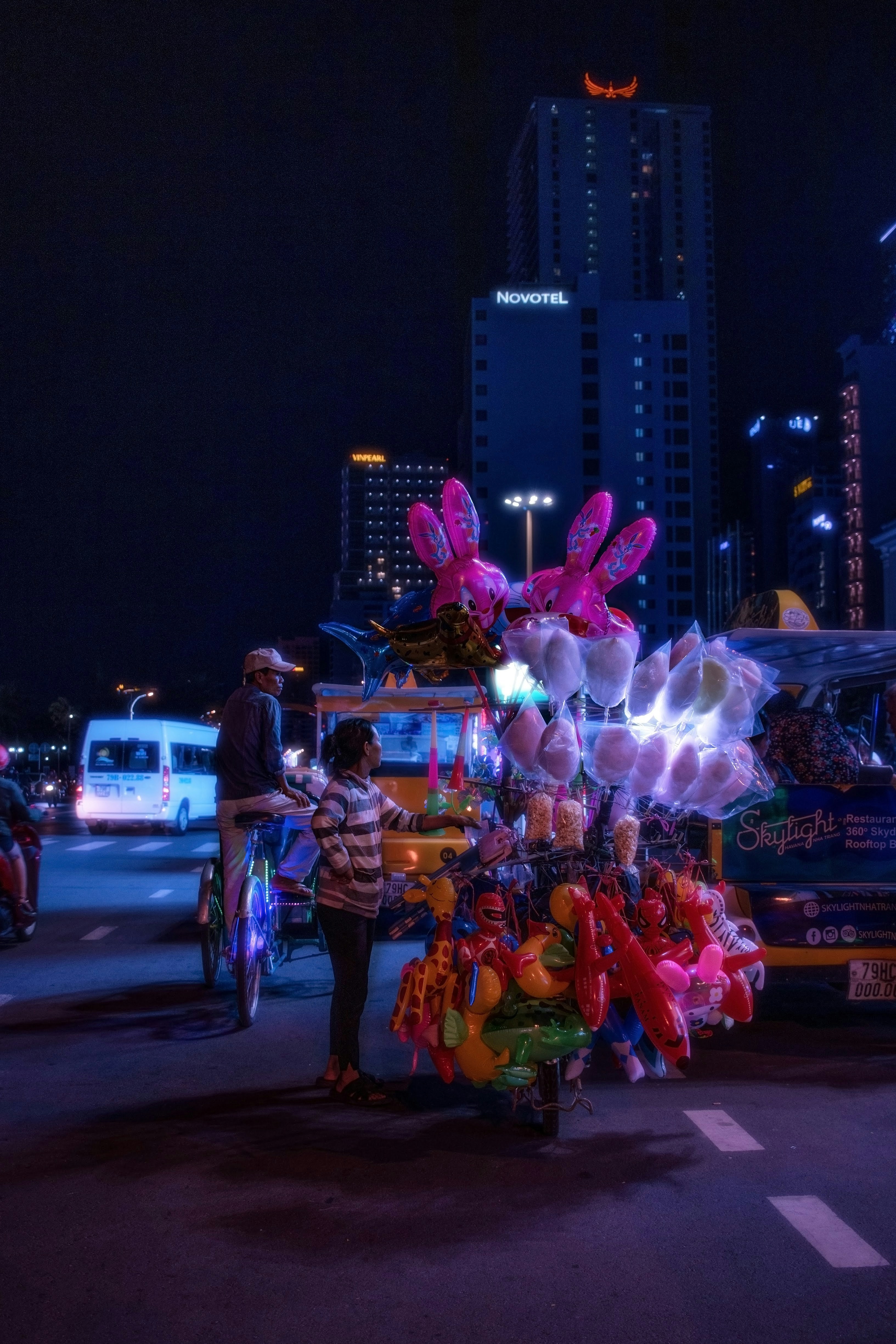 Neon Bunny Balloons at a Night Street Vendor Stand