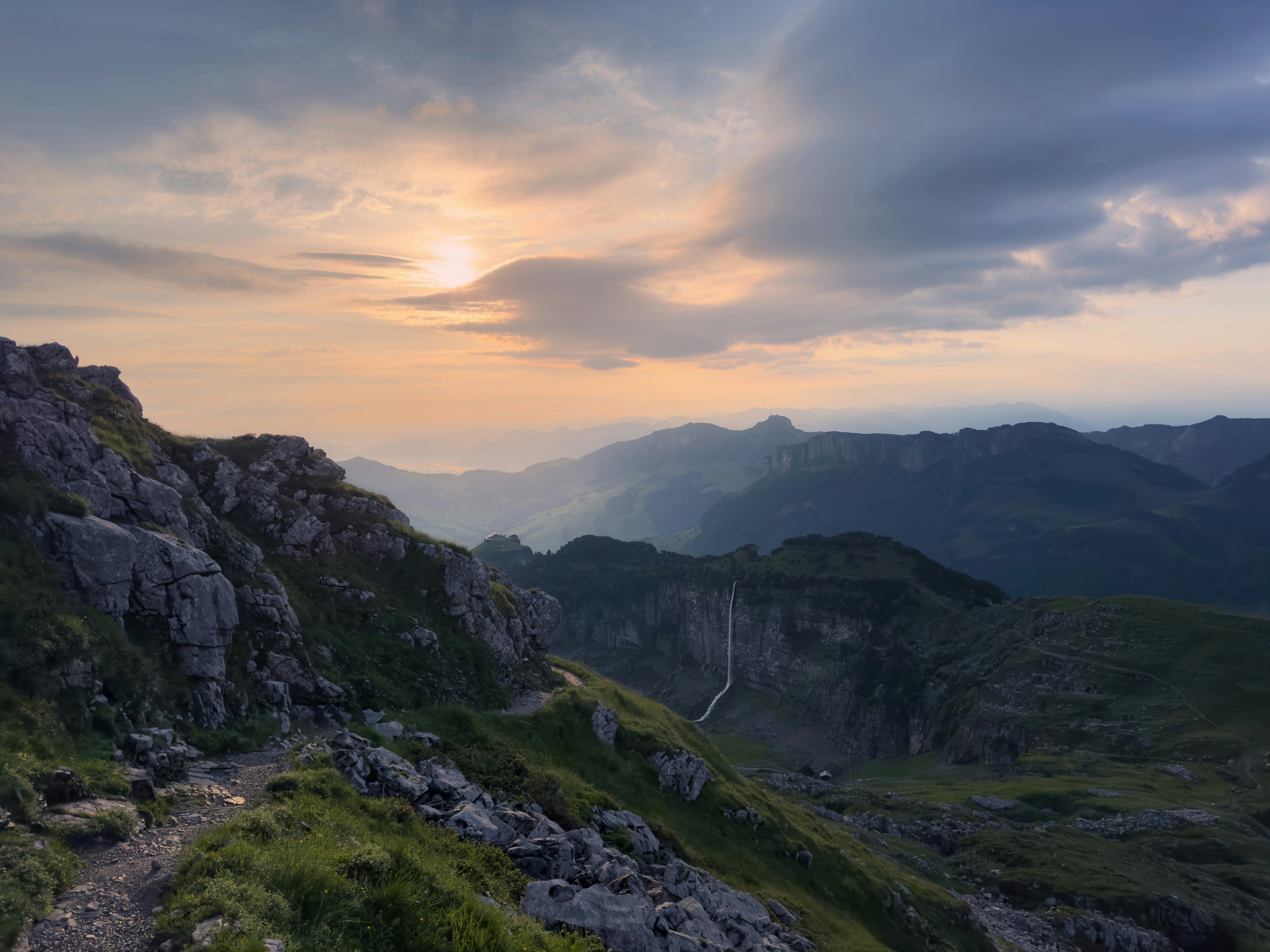 A path going up a mountain with a sunset in the background photo – Free ...
