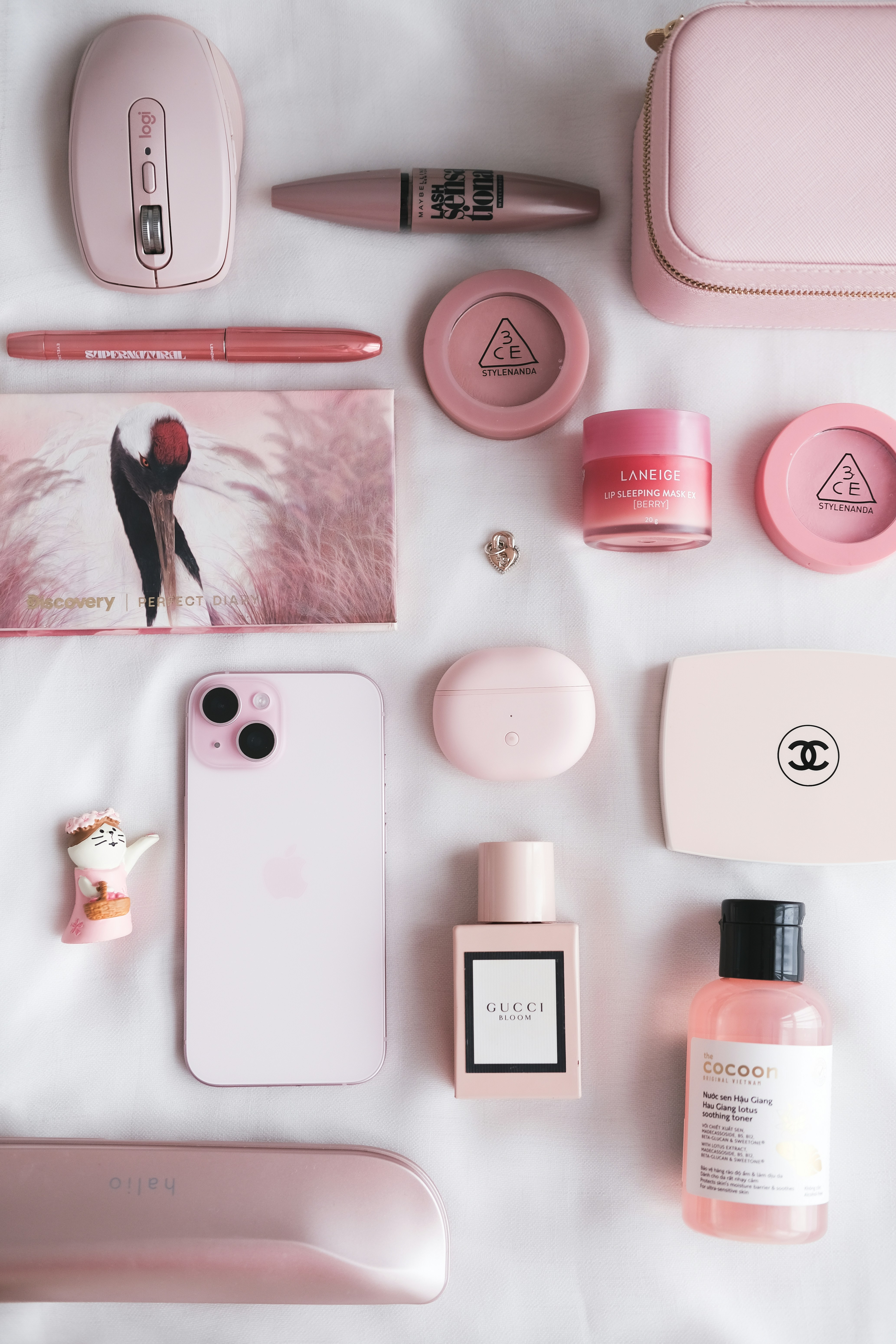The contents of a pink purse laid out on a bed photo – Free Style Image ...