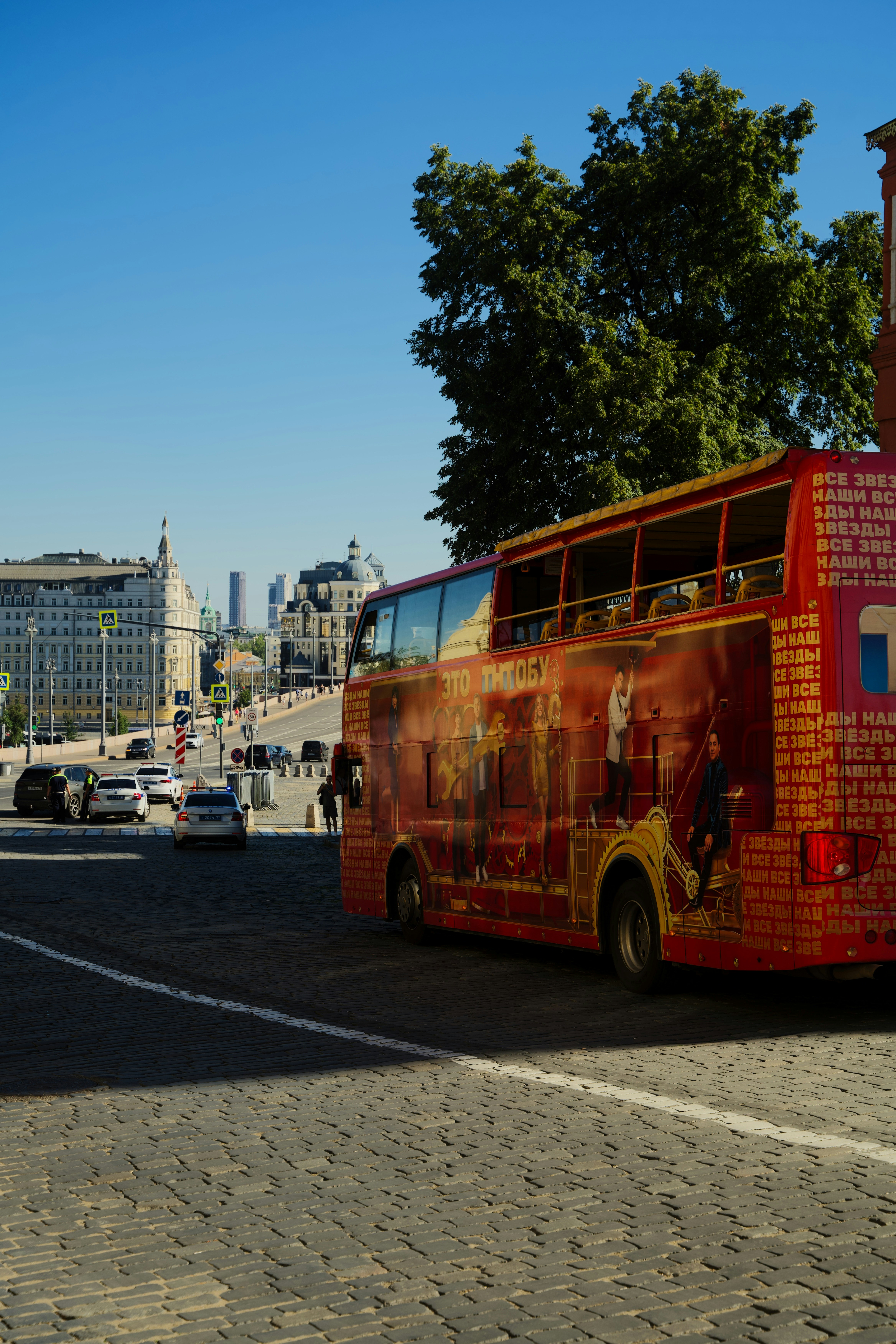 A red double decker bus driving down a street photo – Free Moscow Image ...