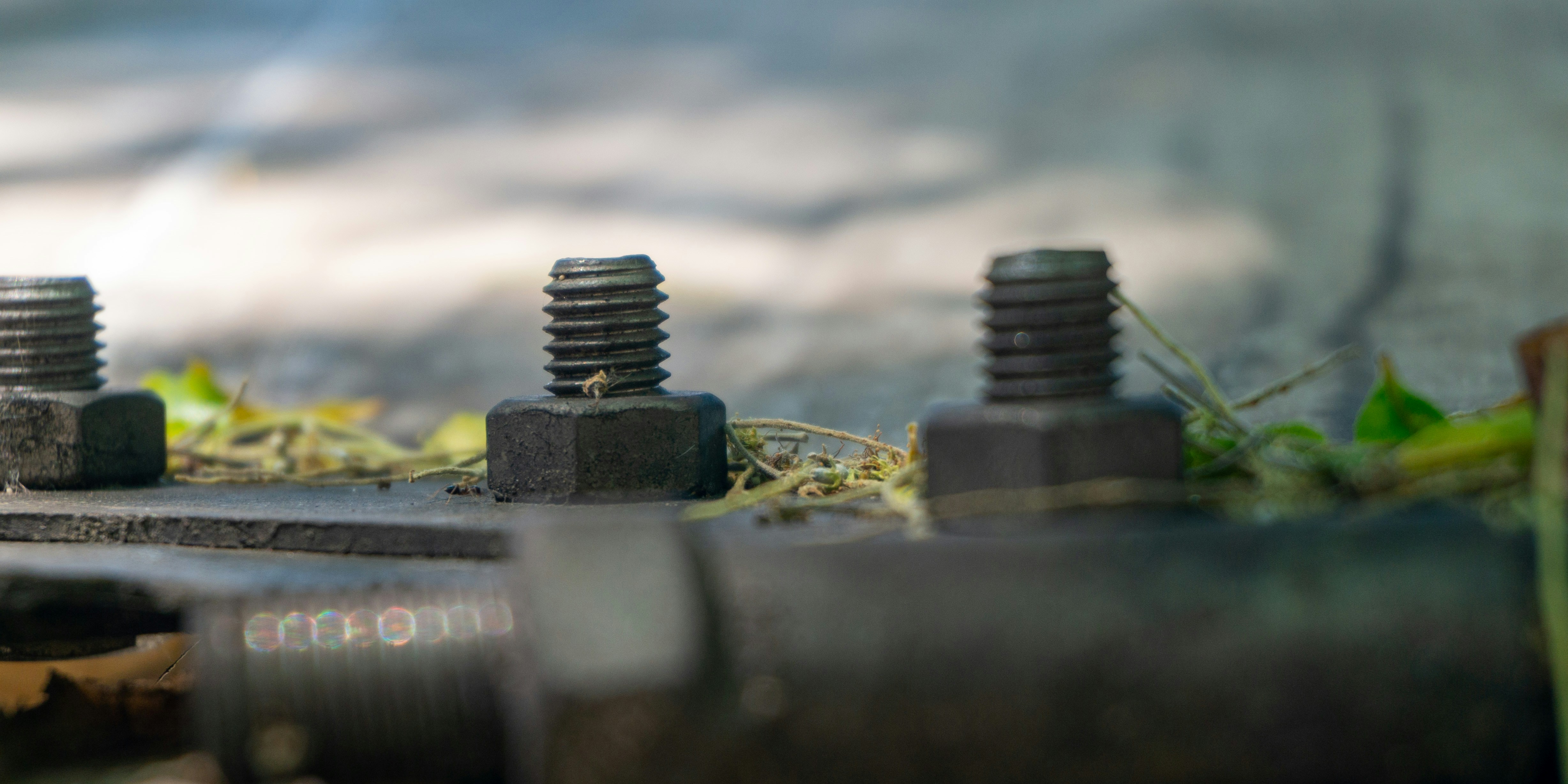 A couple of screws sitting on top of a street