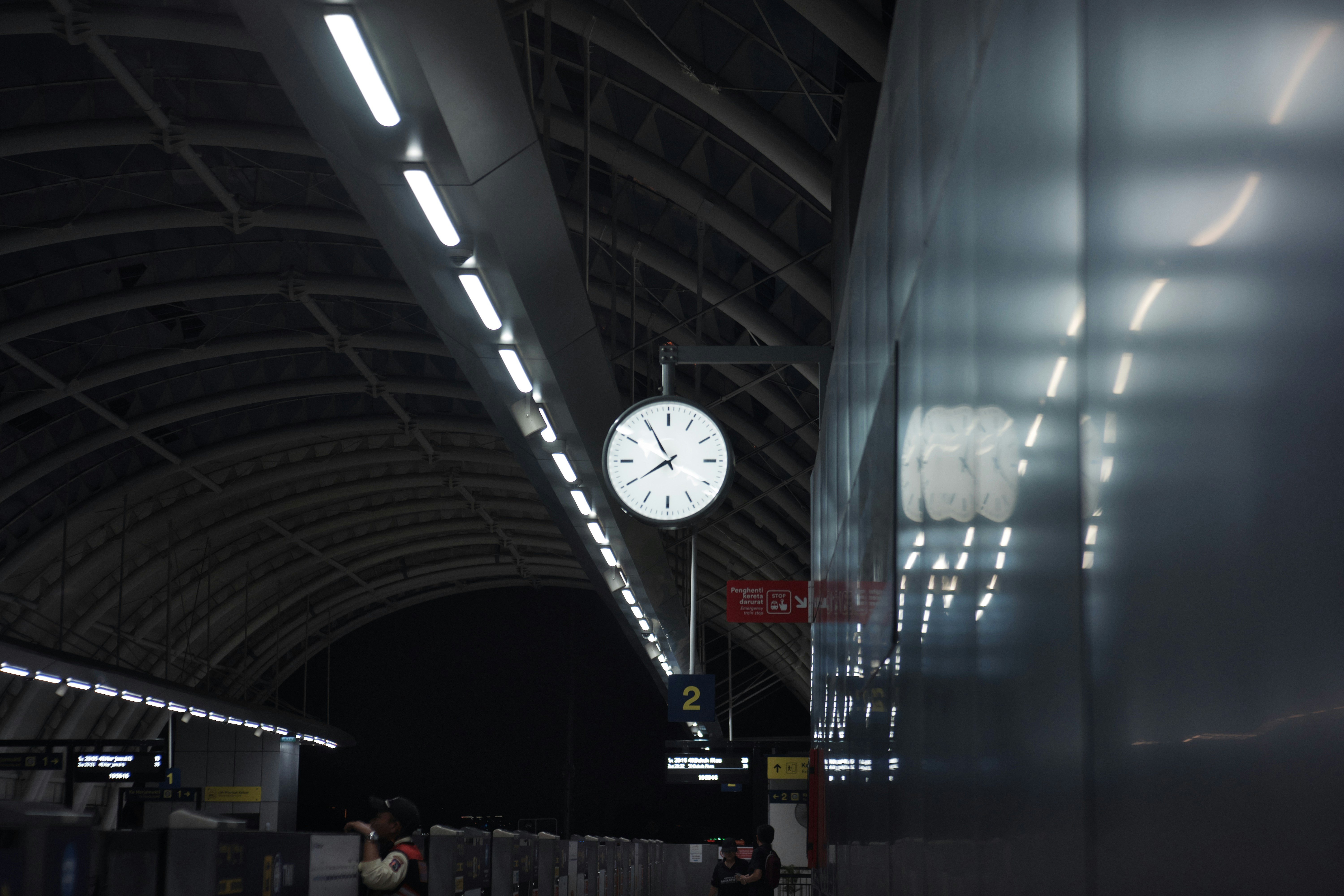 A train station with a clock on the wall photo – Free Stasiun lrt taman ...
