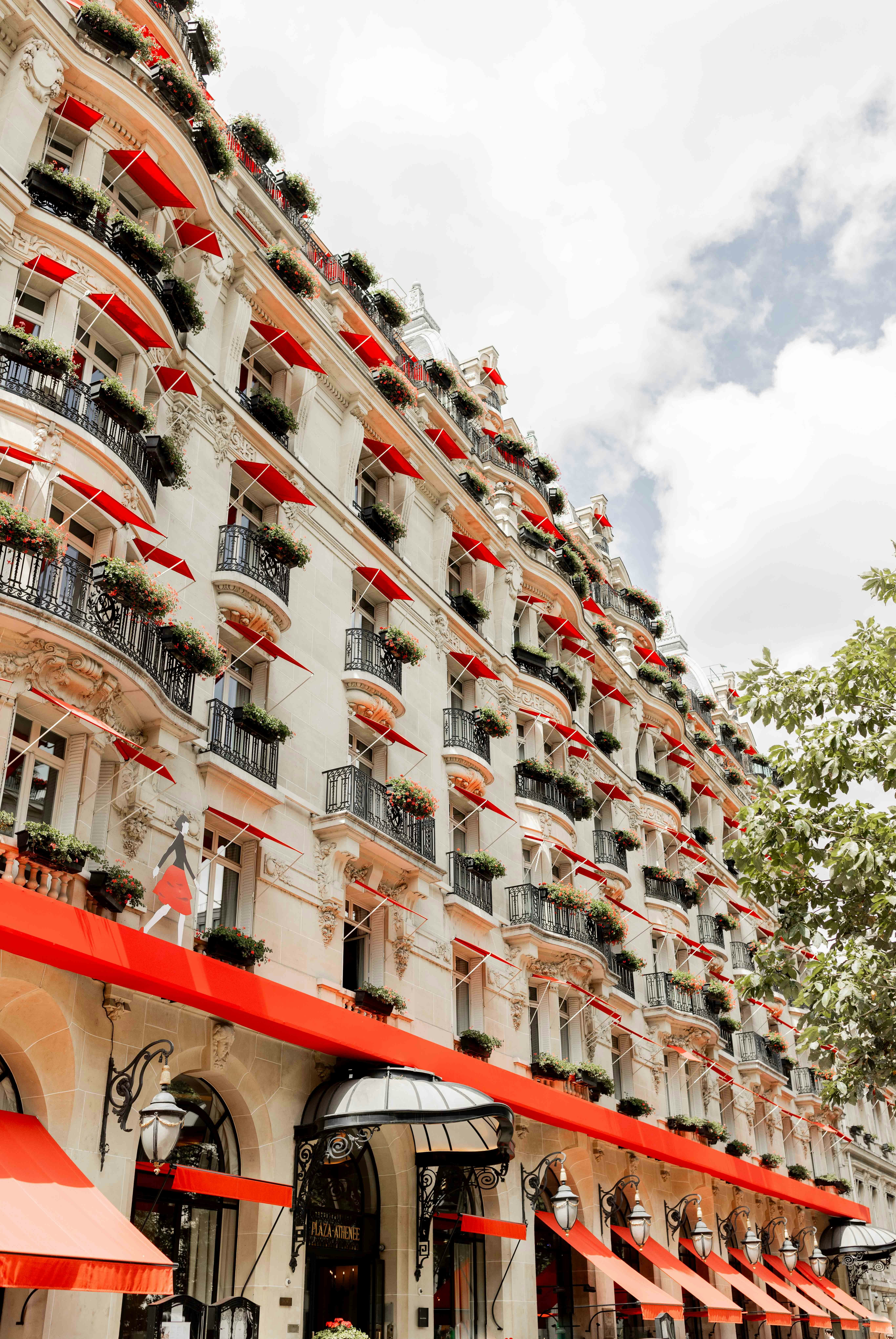 A very tall building with red awnings on the side of it photo – Free ...