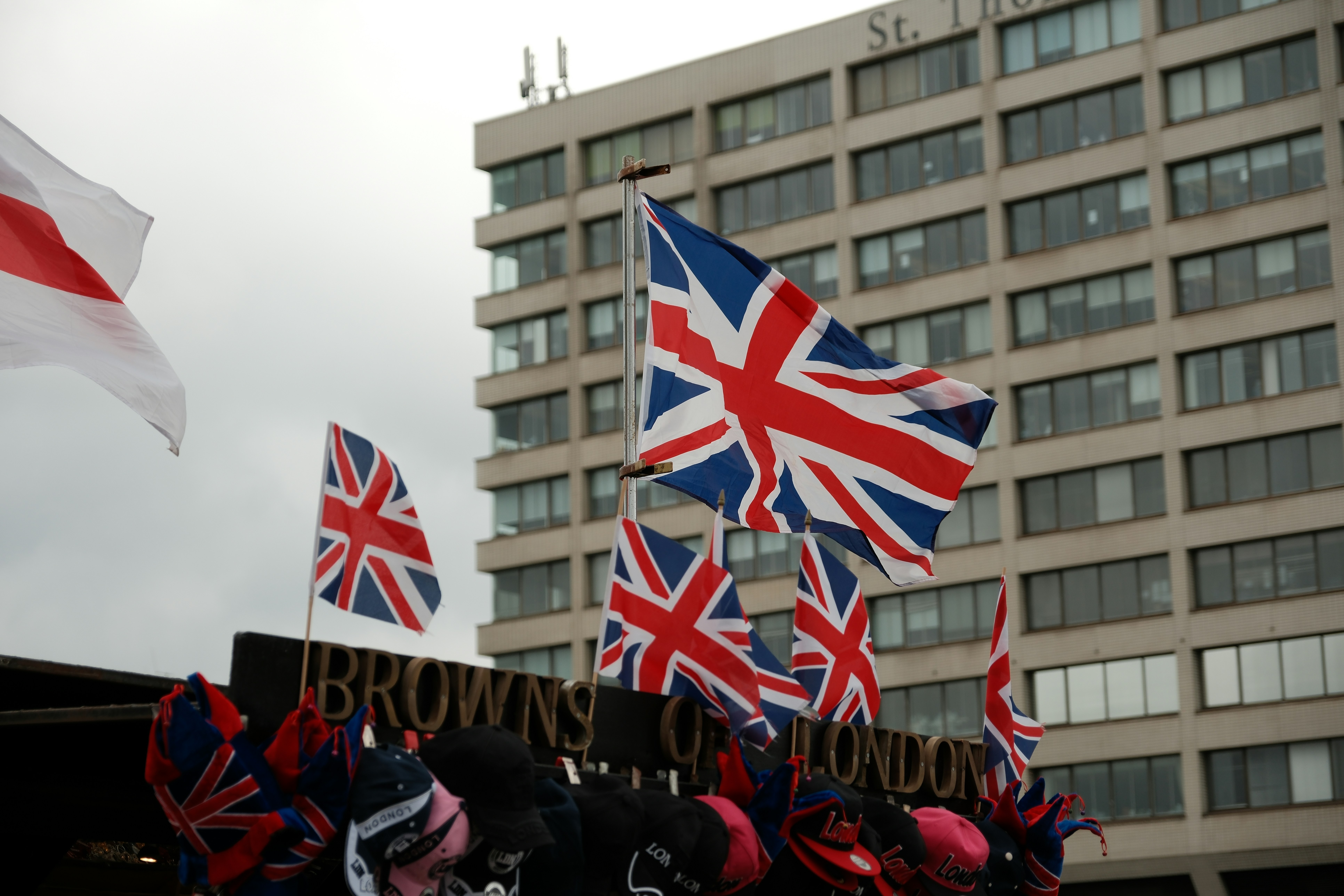 A group of british flags flying in front of a building