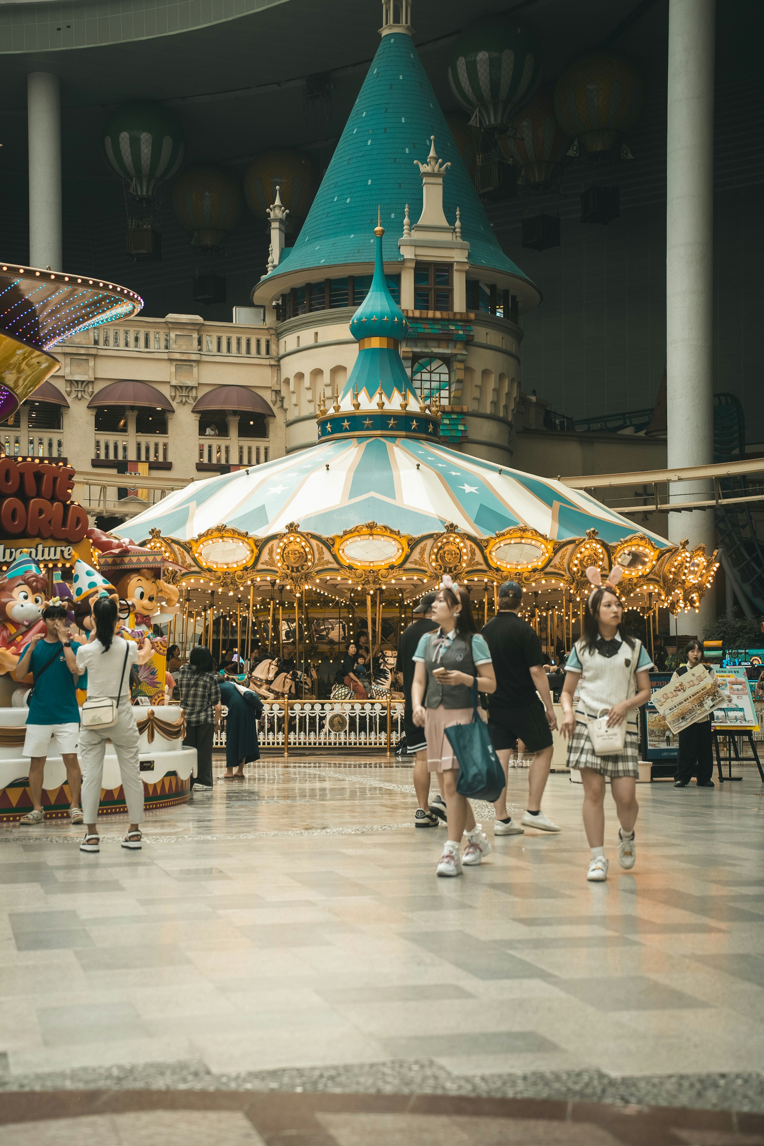 A group of people standing around a carousel photo – Free Woman Image ...