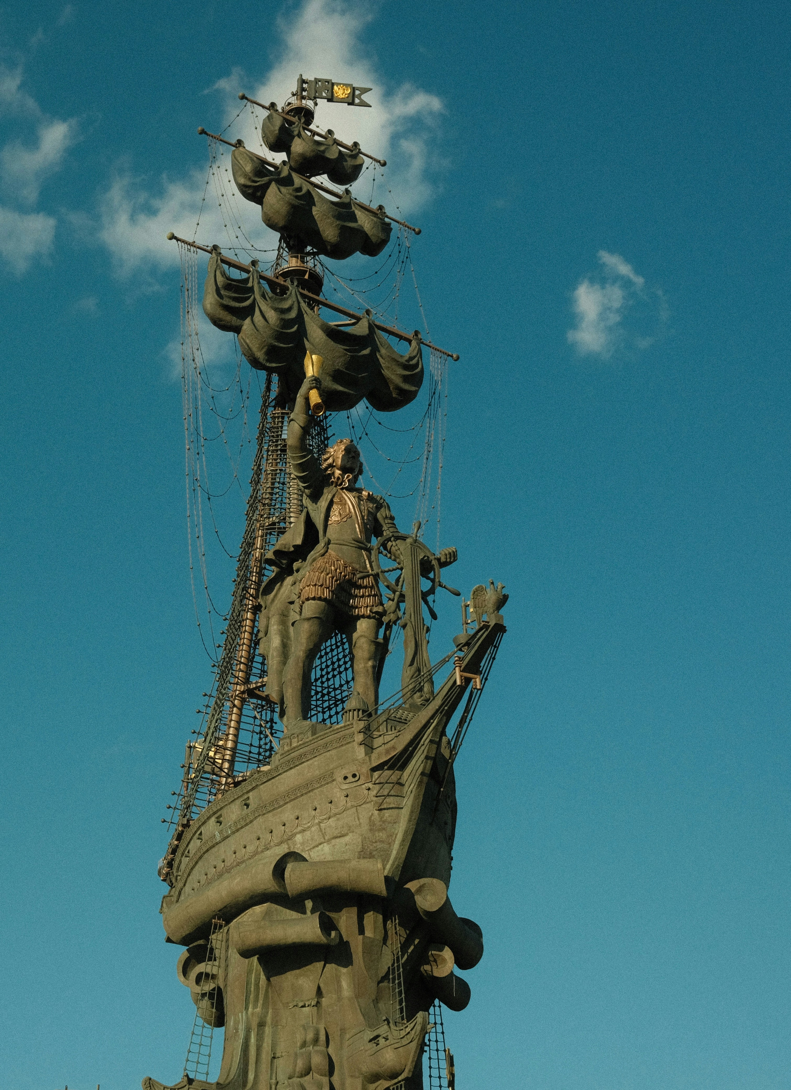 Monumental Helmsman: A Ship-Deck Statue Reaching Toward the Blue Sky