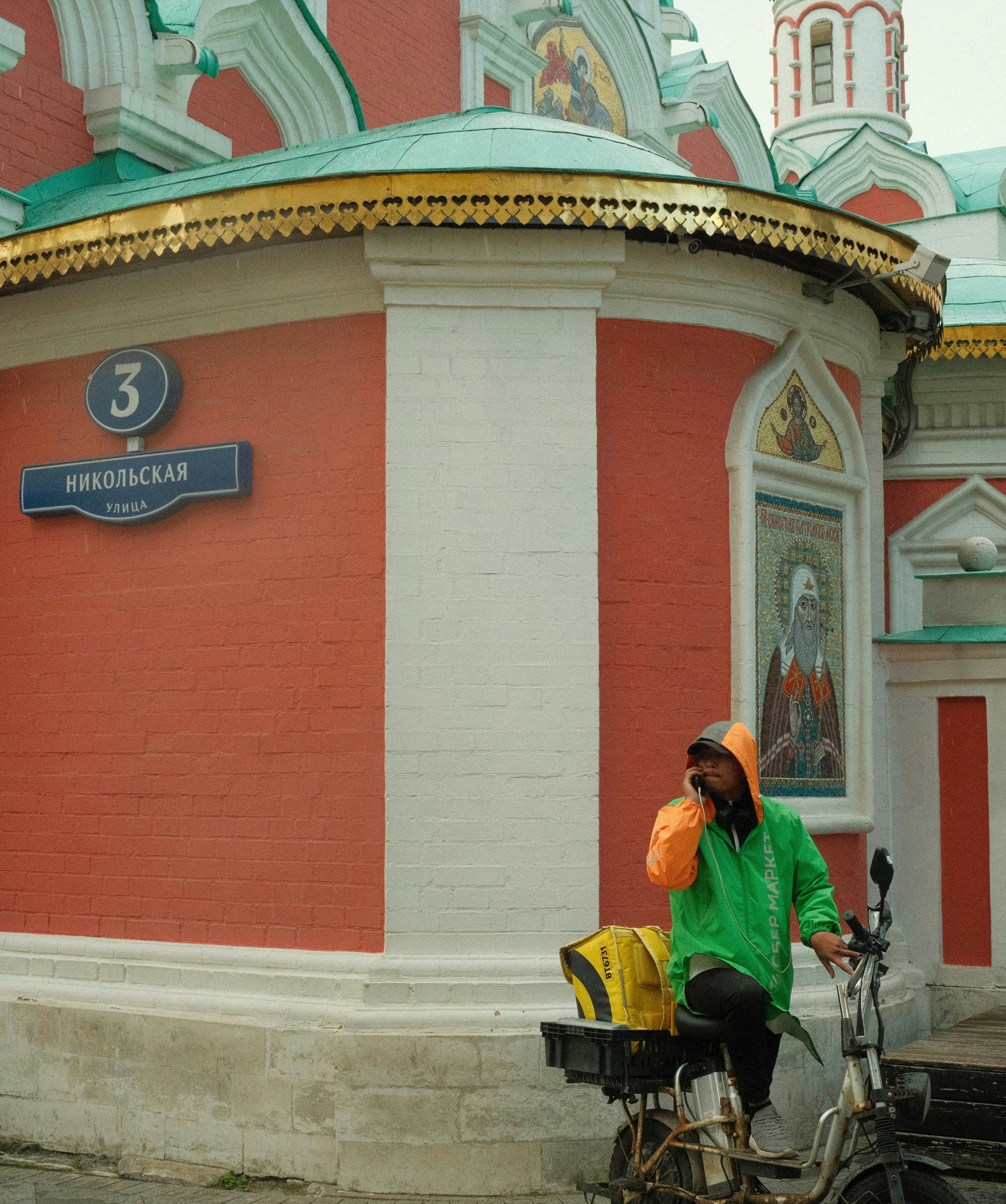 Neon-green rider by a color-saturated church corner