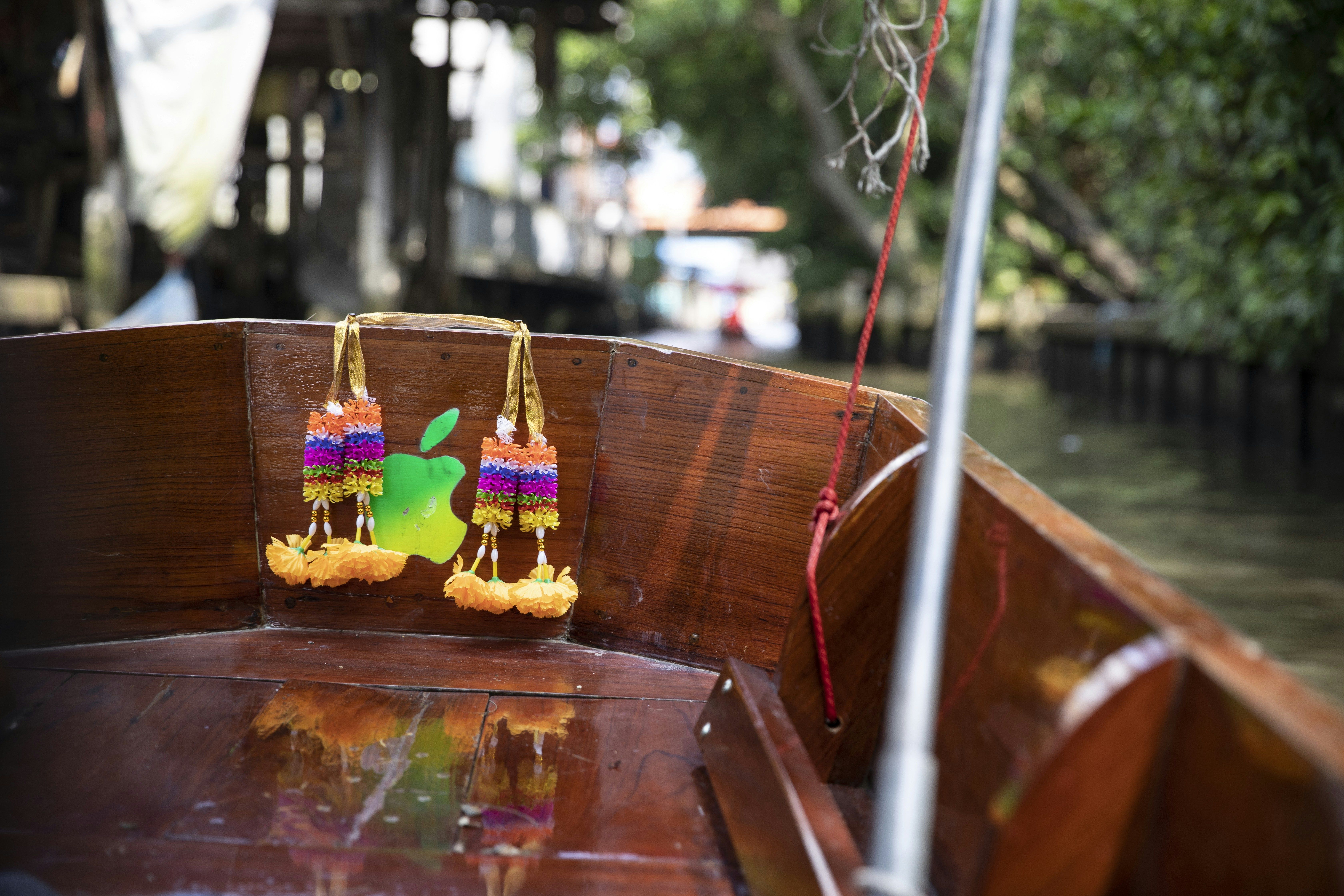 Floating Talisman: Colorful Ornaments Adrift in a Wooden Boat
