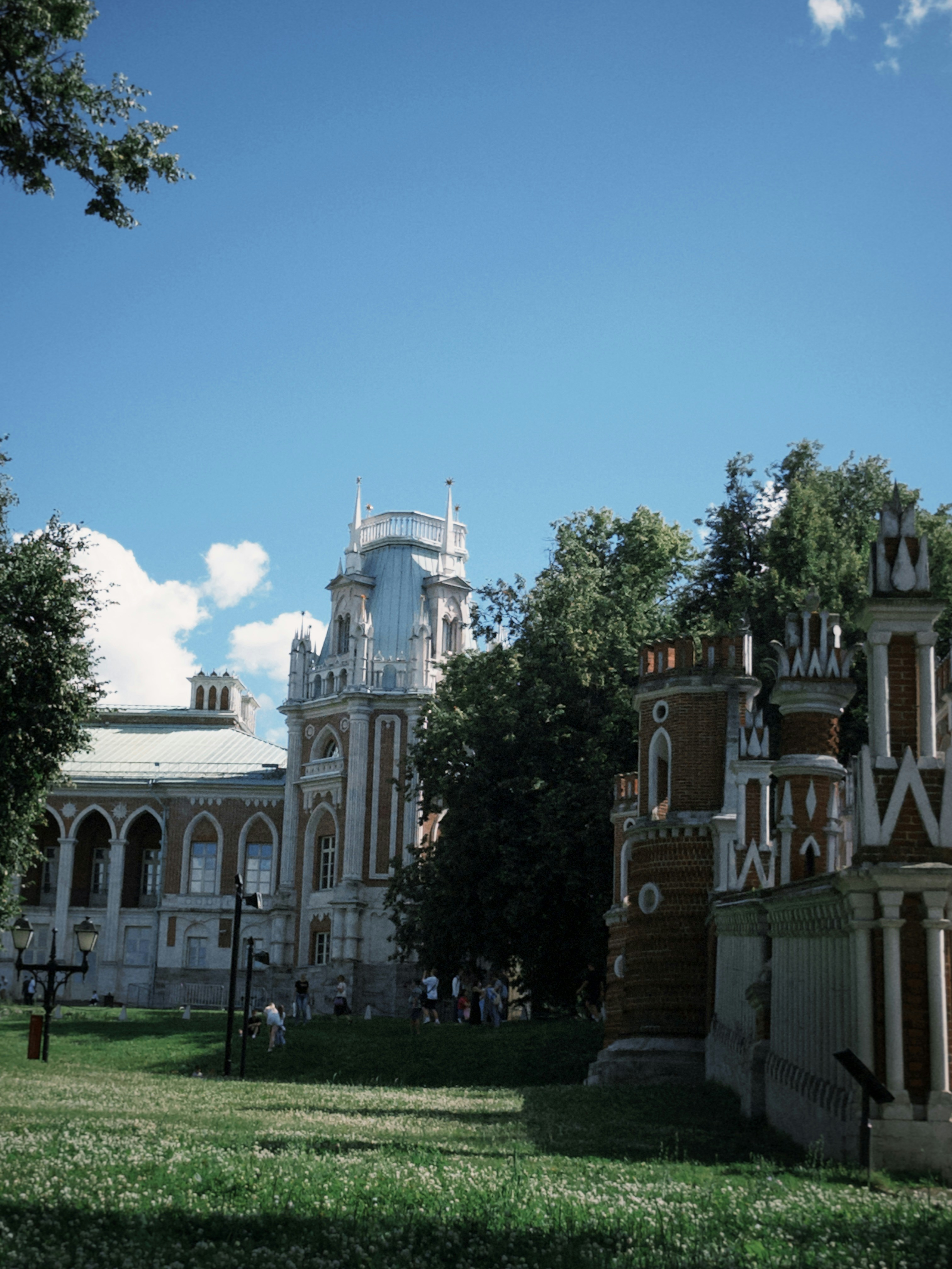 Ivory Central Tower Surrounded by Brick Turrets Beneath a Cerulean Sky