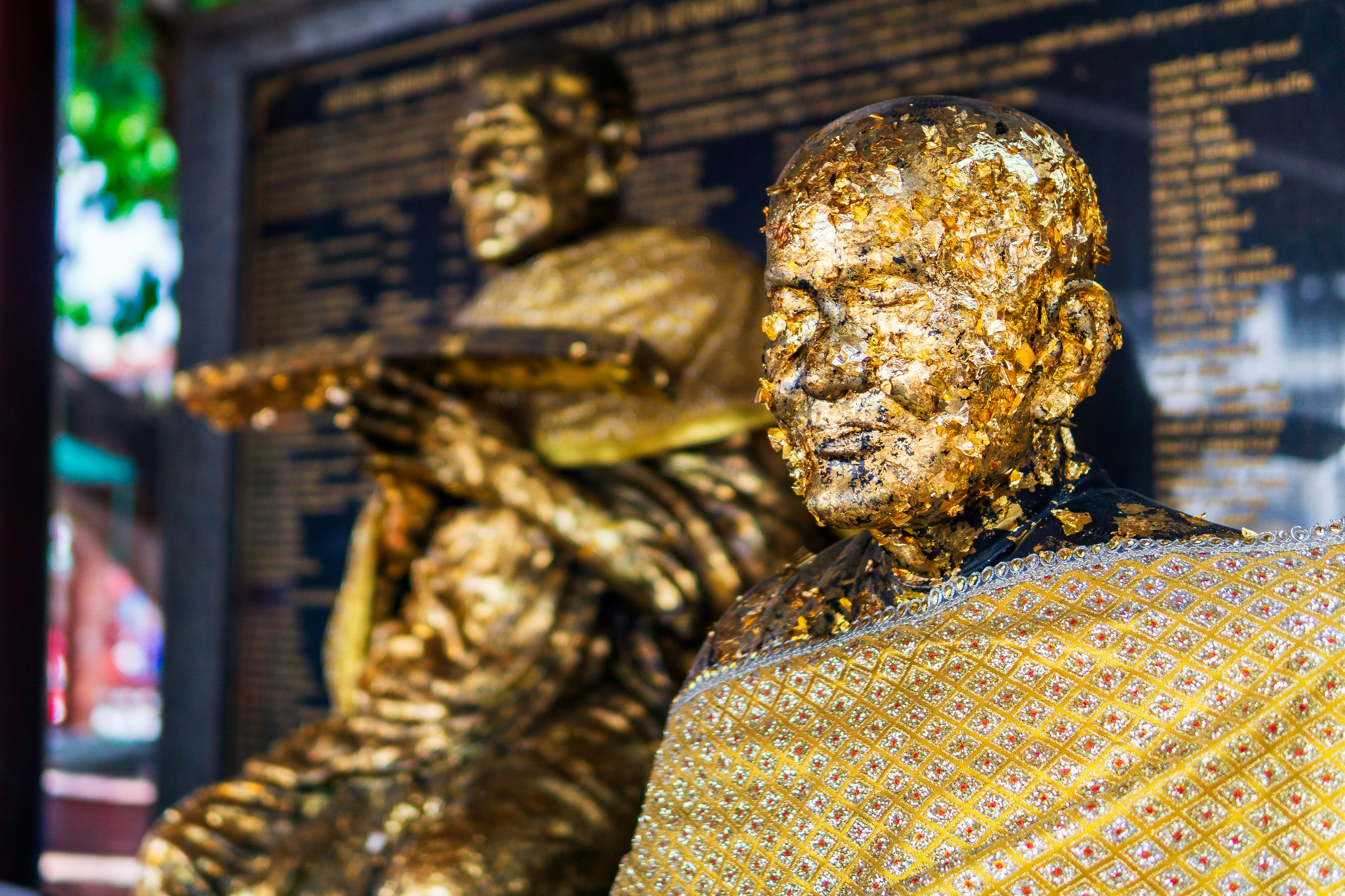 A statue of a man holding a tray of food photo – Free Temple Image on ...