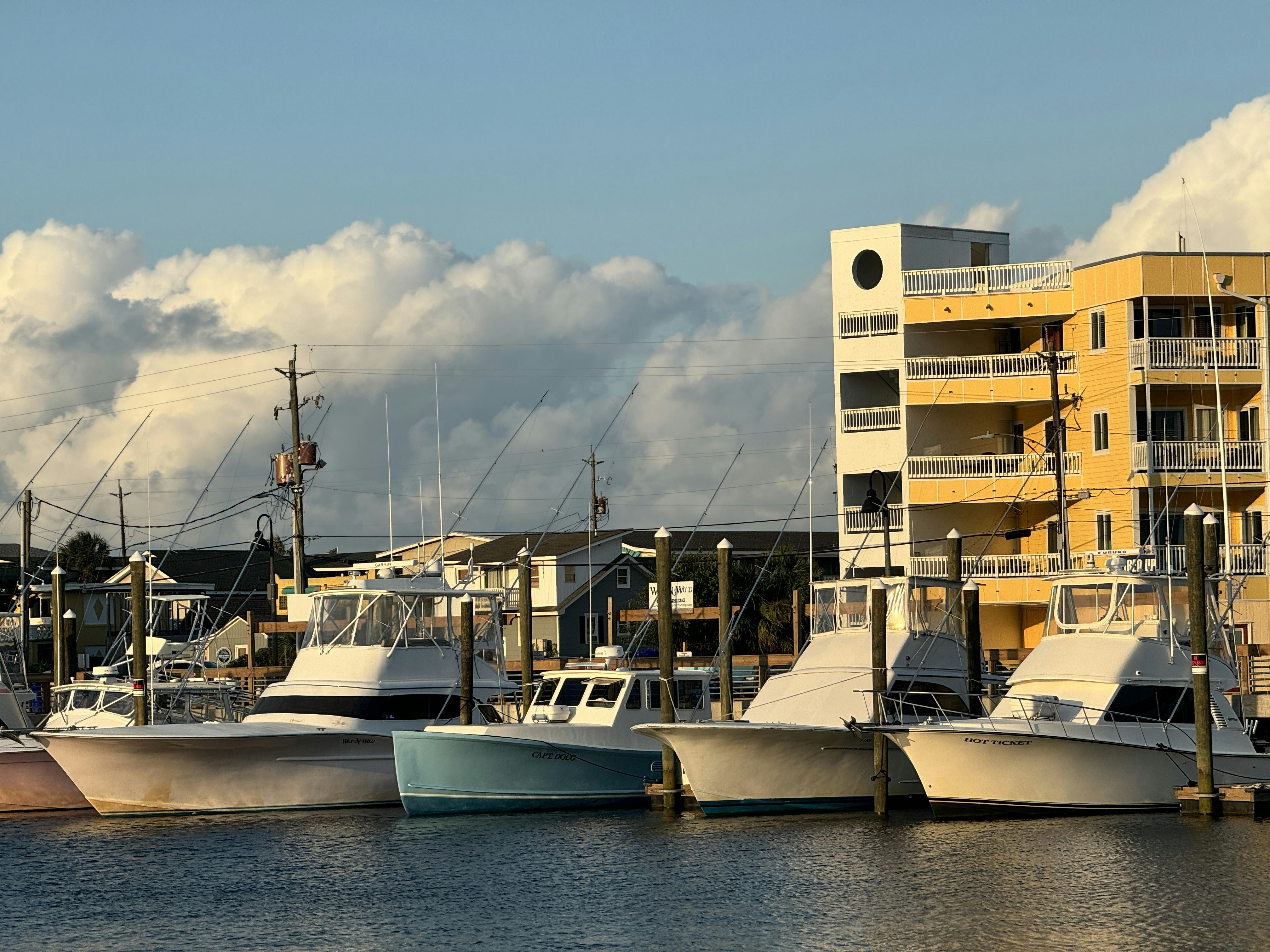 A group of boats sitting in a harbor next to a building photo – Free ...