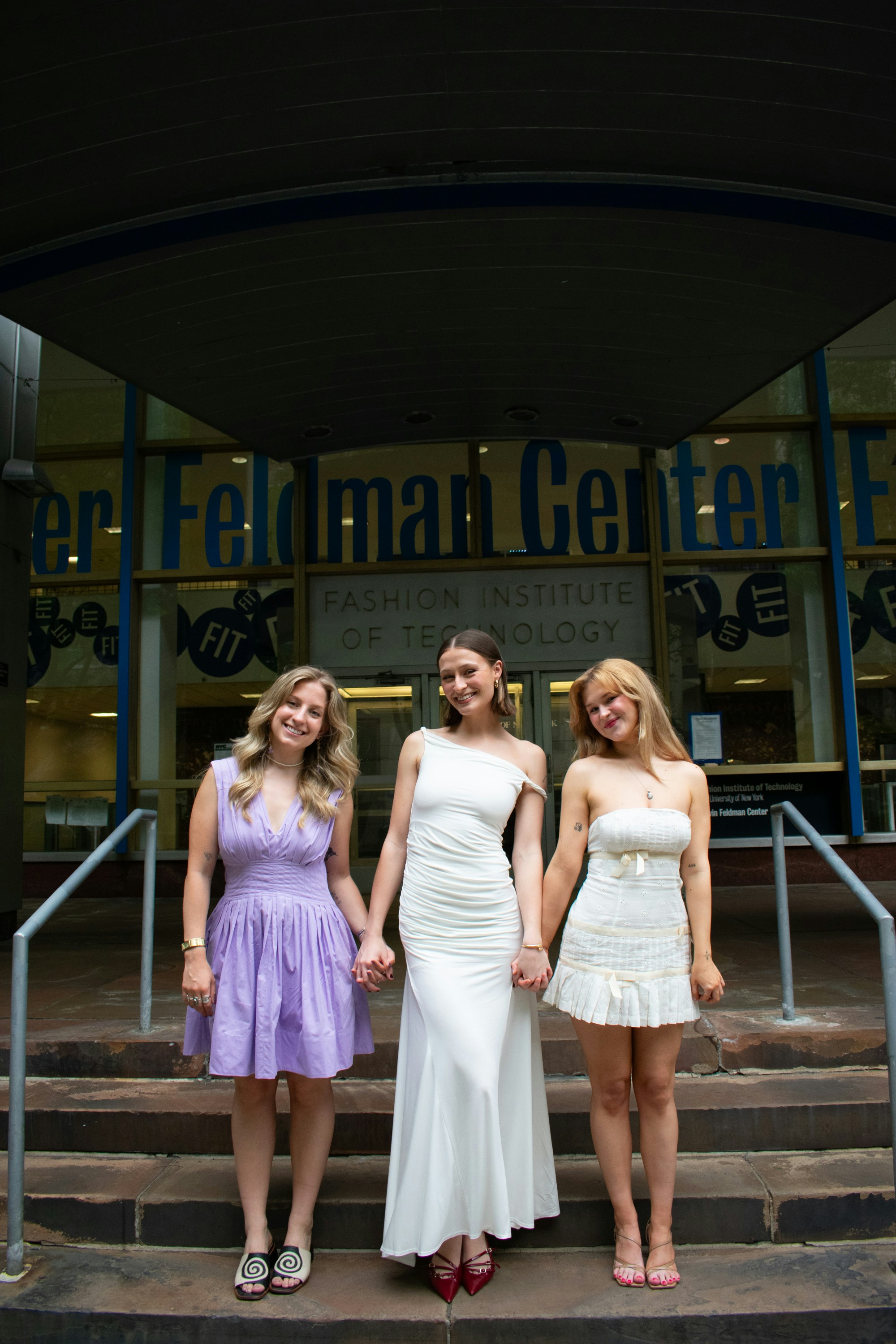 Three women standing on steps in front of a building photo – Free Woman ...