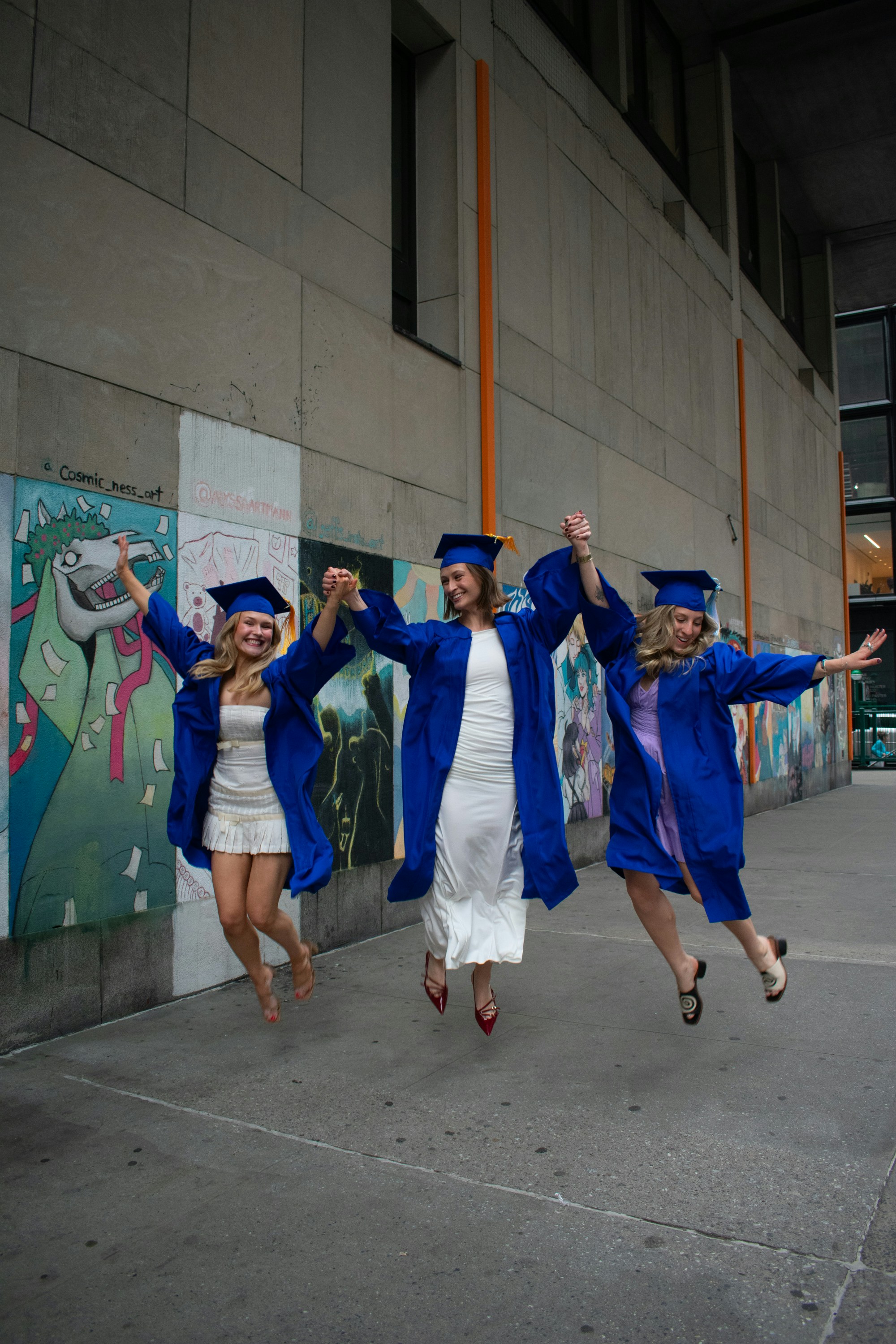 A group of graduates jumping in the air photo – Free Portrait Image on ...