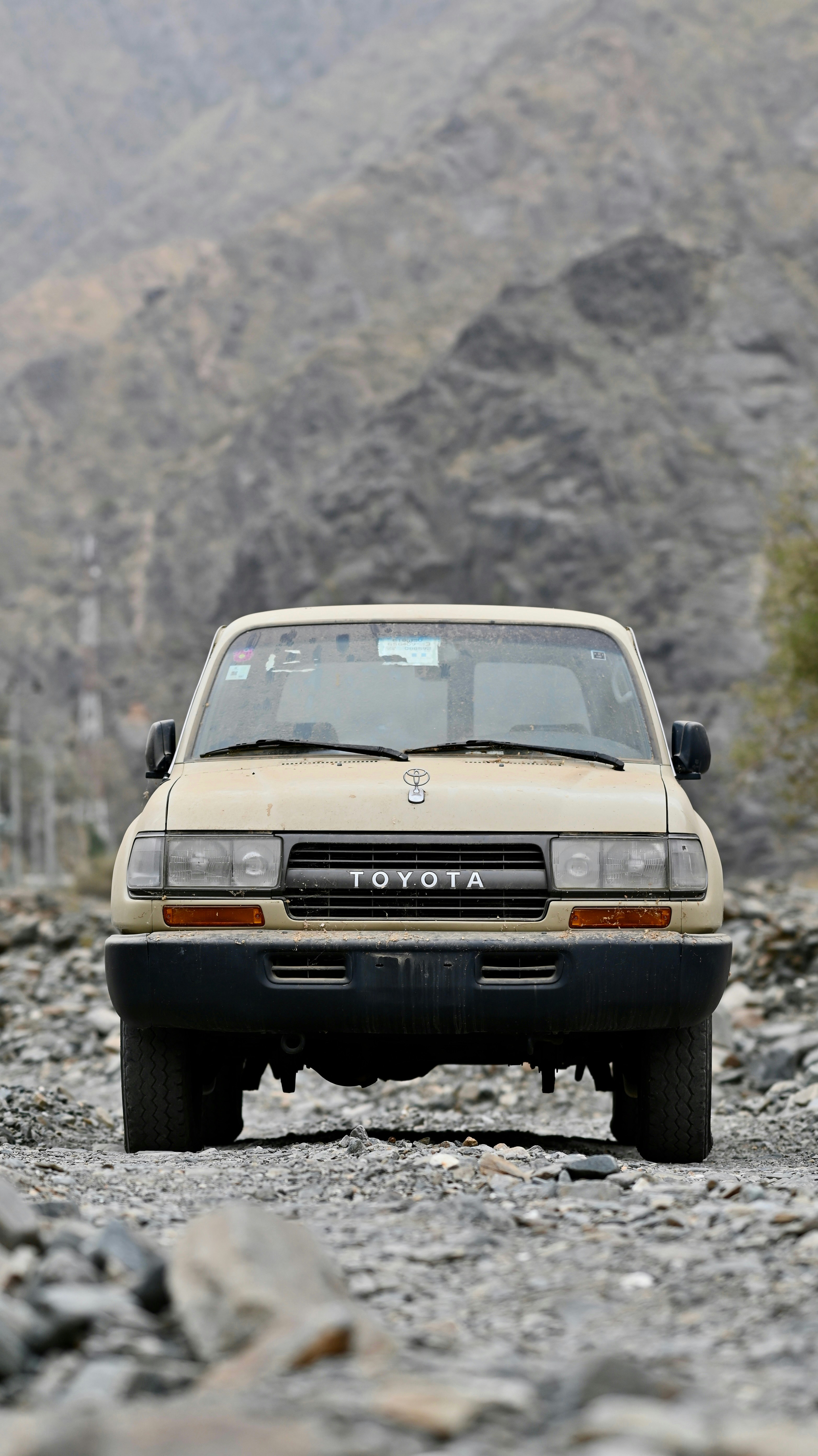 Beige Toyota SUV on a Rugged Mountain Gravel Pass