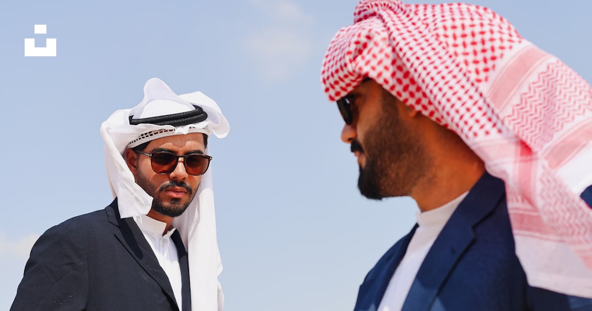 A Couple Of Men Standing Next To Each Other Photo Free Man Image On