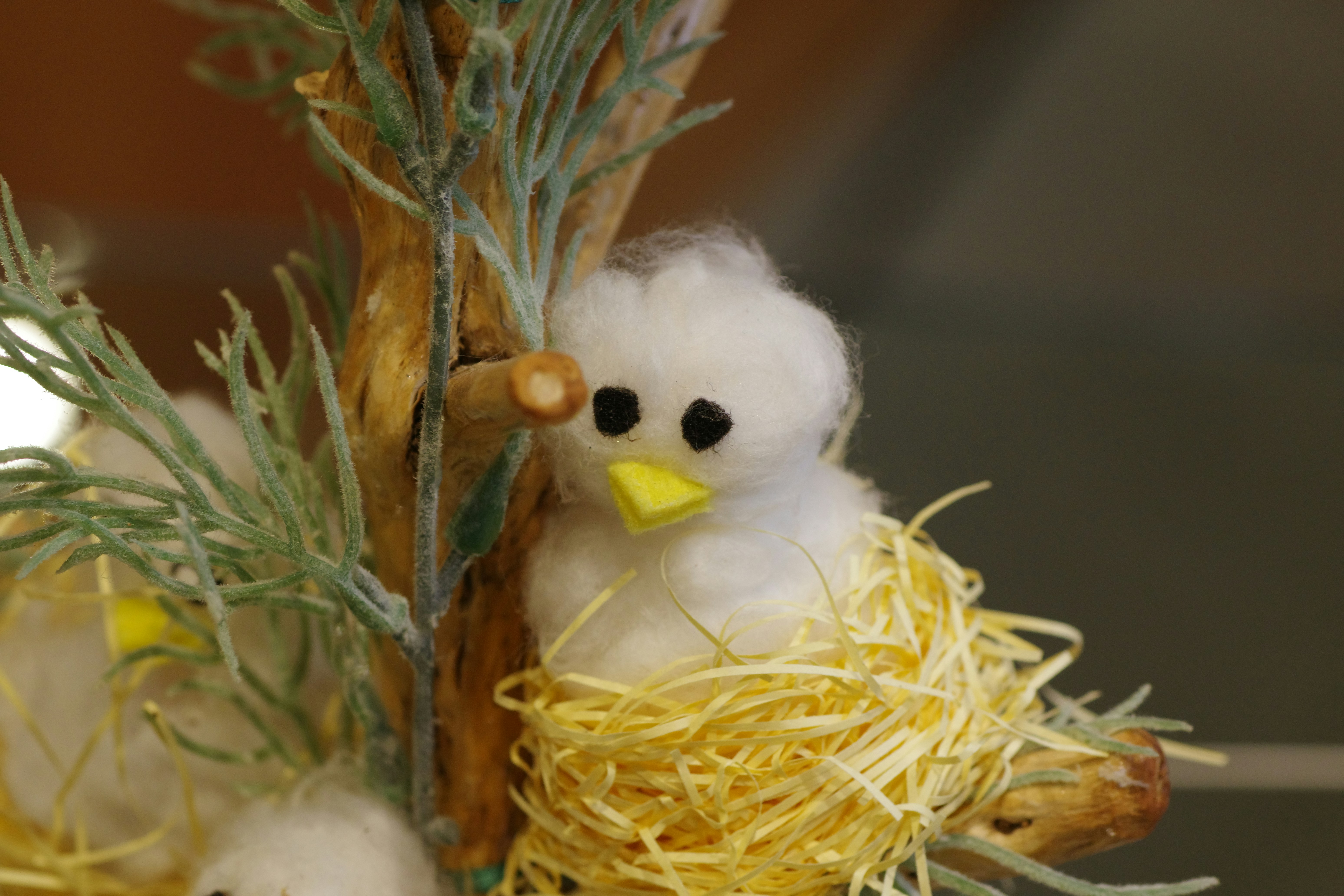 Nestbound Whimsy: A Tiny Plush Chick in Golden Straw