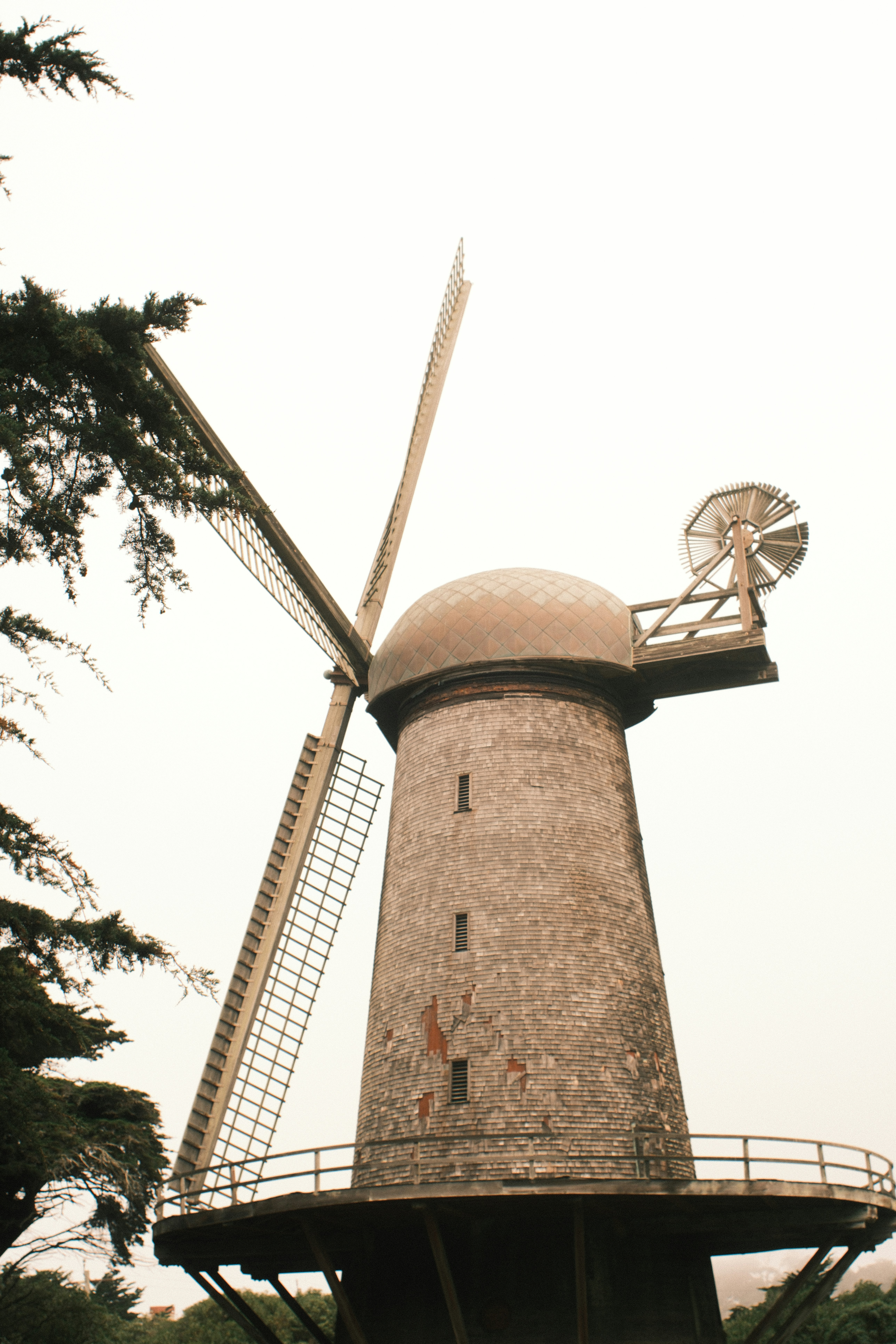 Sepia Windmill: Weathered Brick Tower Reaching Toward a Pale Sky