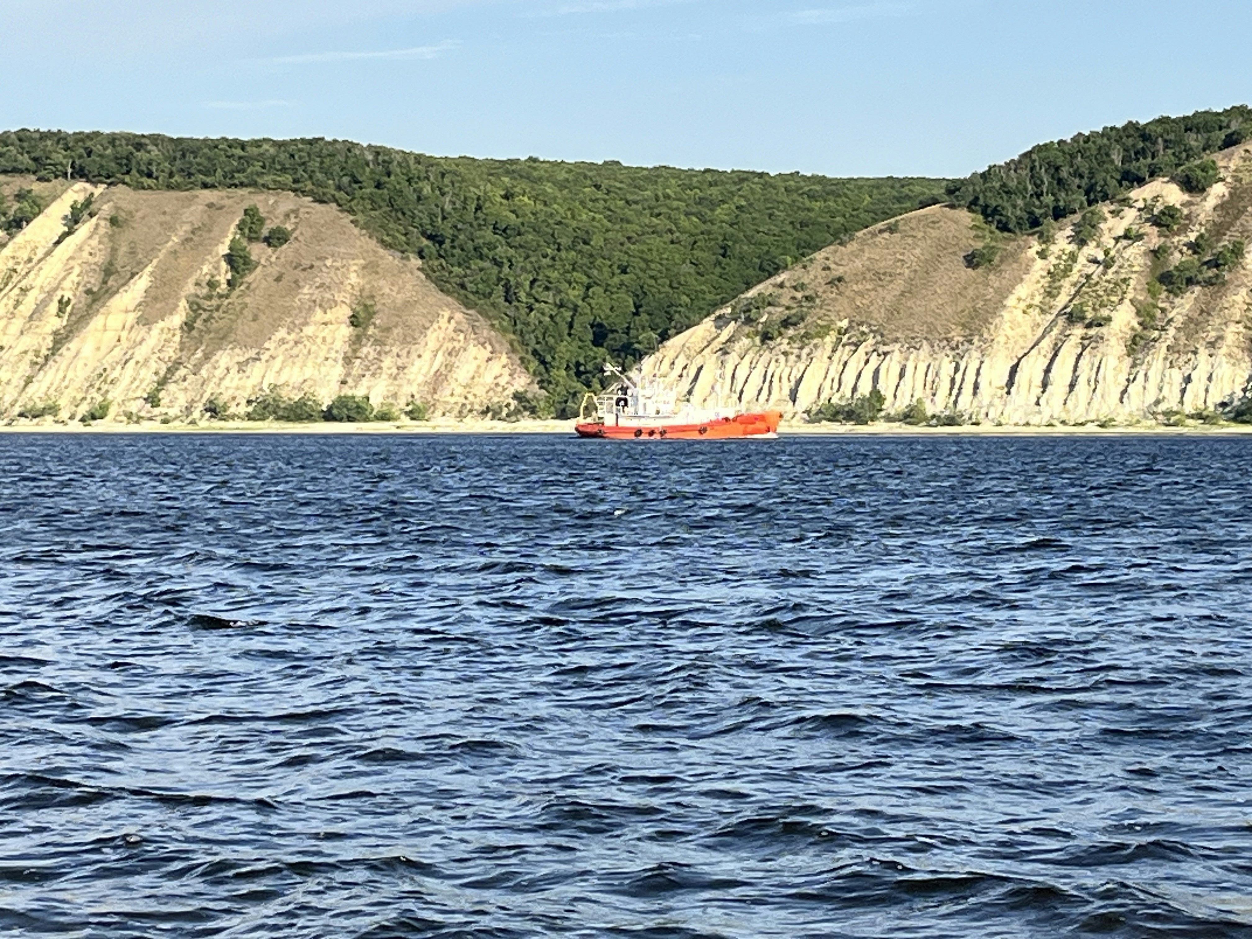 Red Tug Against a Chalky Coast: Sea, Cliffs, and Green Hills