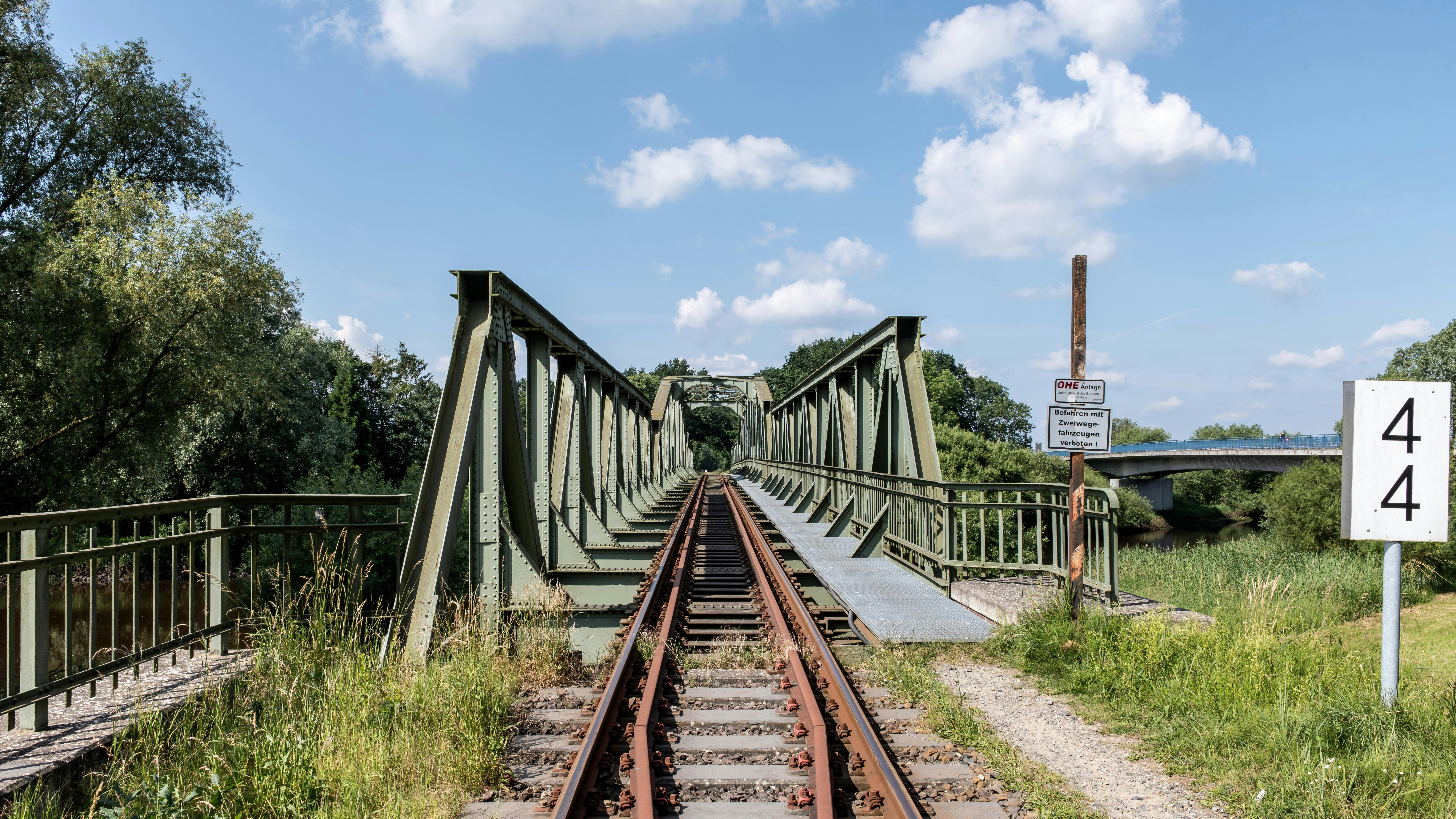 A train track going over a bridge over water photo – Free Winsen (luhe ...