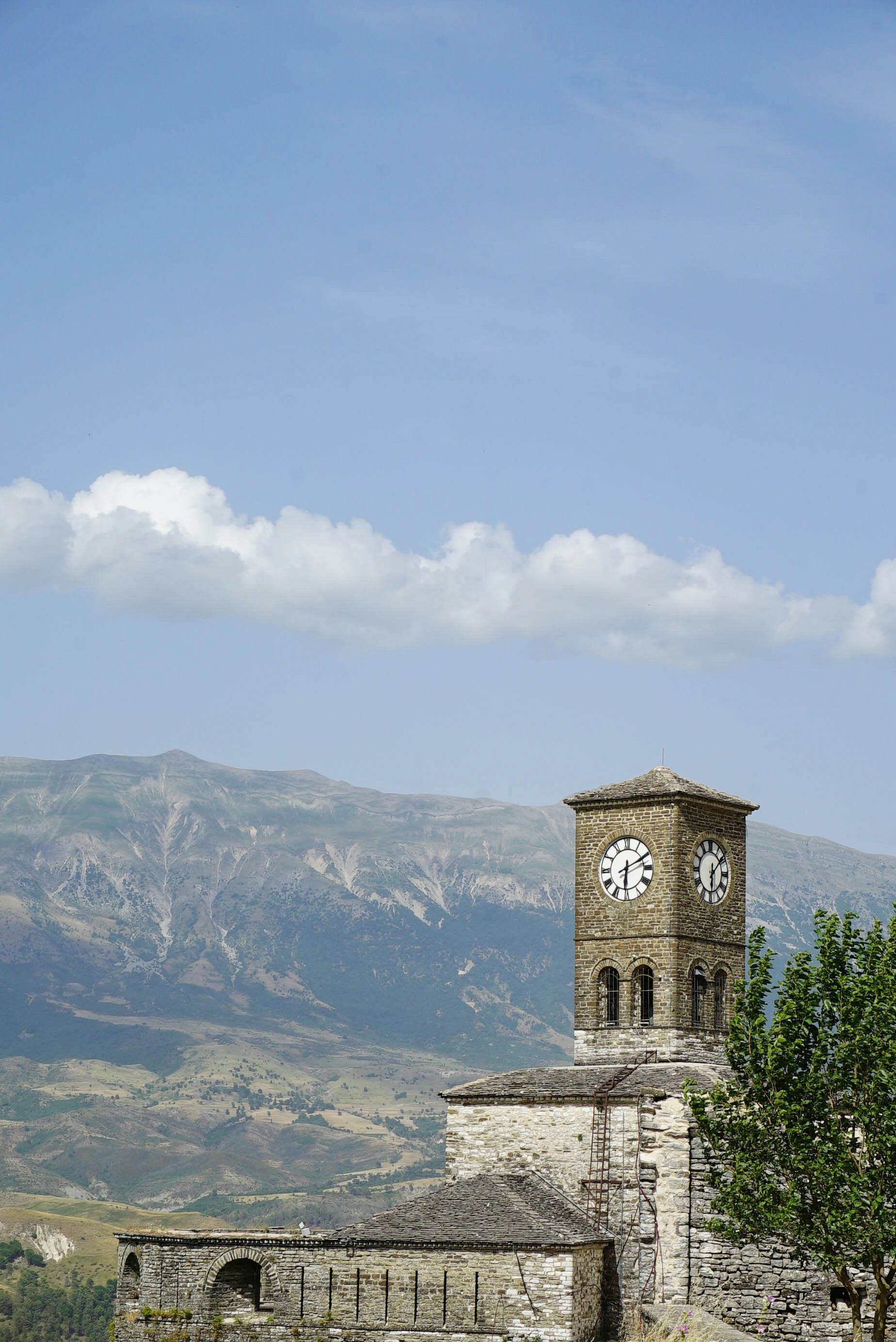 Stone Clocktower at the Edge of the Alpine Horizon