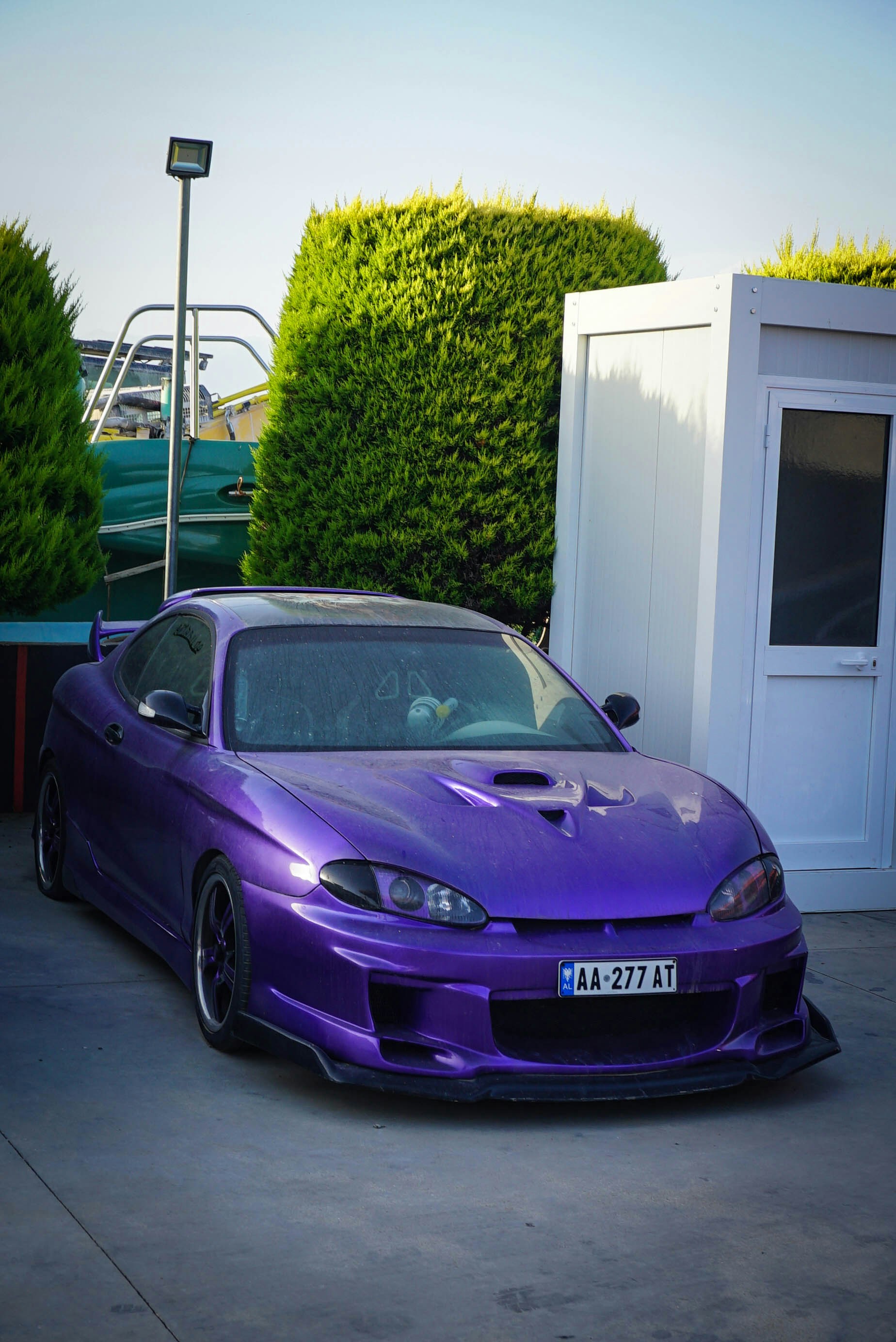Purple Velocity: A Tuned Coupe Anchored by a Sunlit Parking Lot