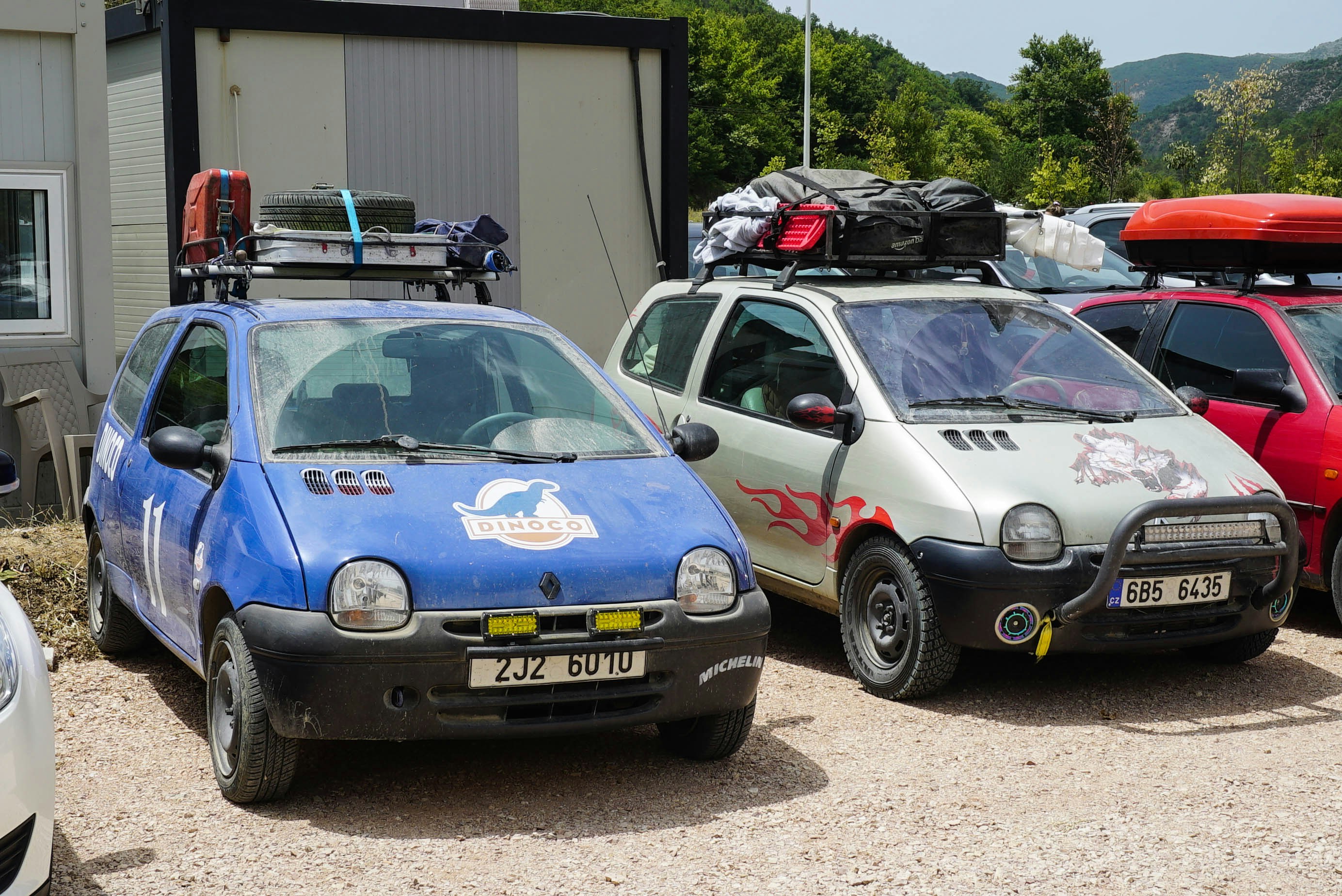Blue hatchback with roof cargo, ready for a road trip