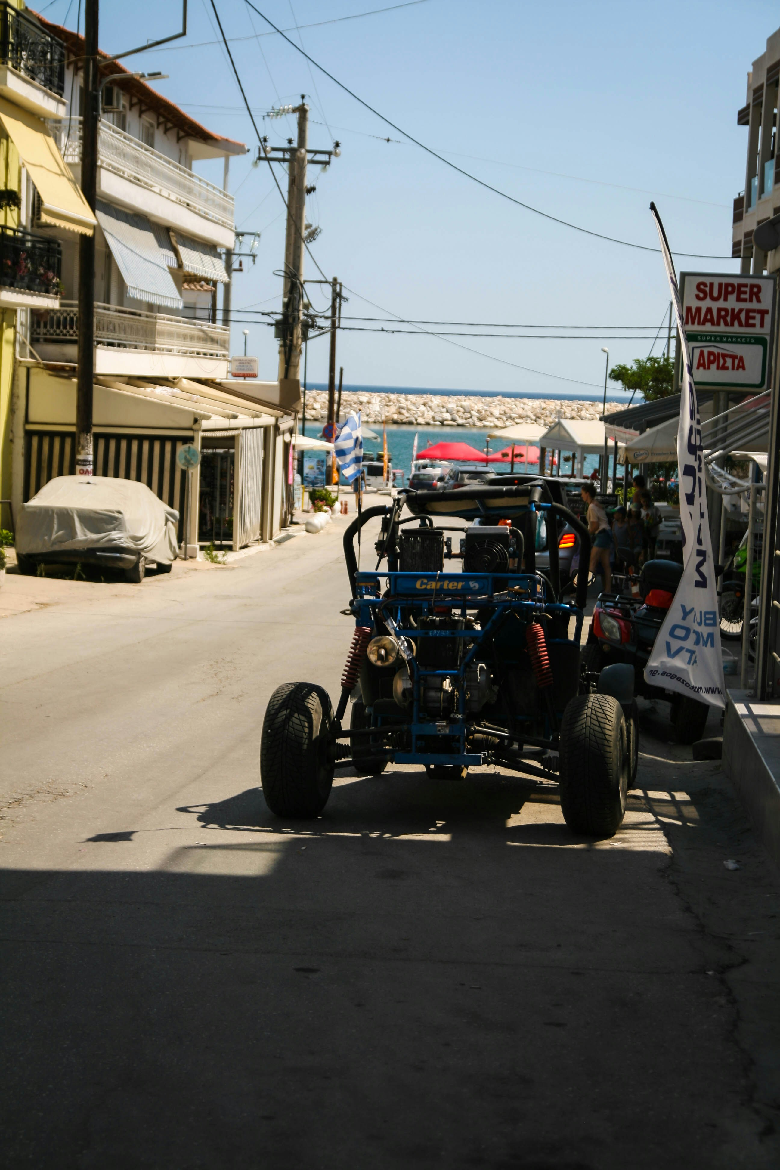 A buggy driving down a street next to tall buildings