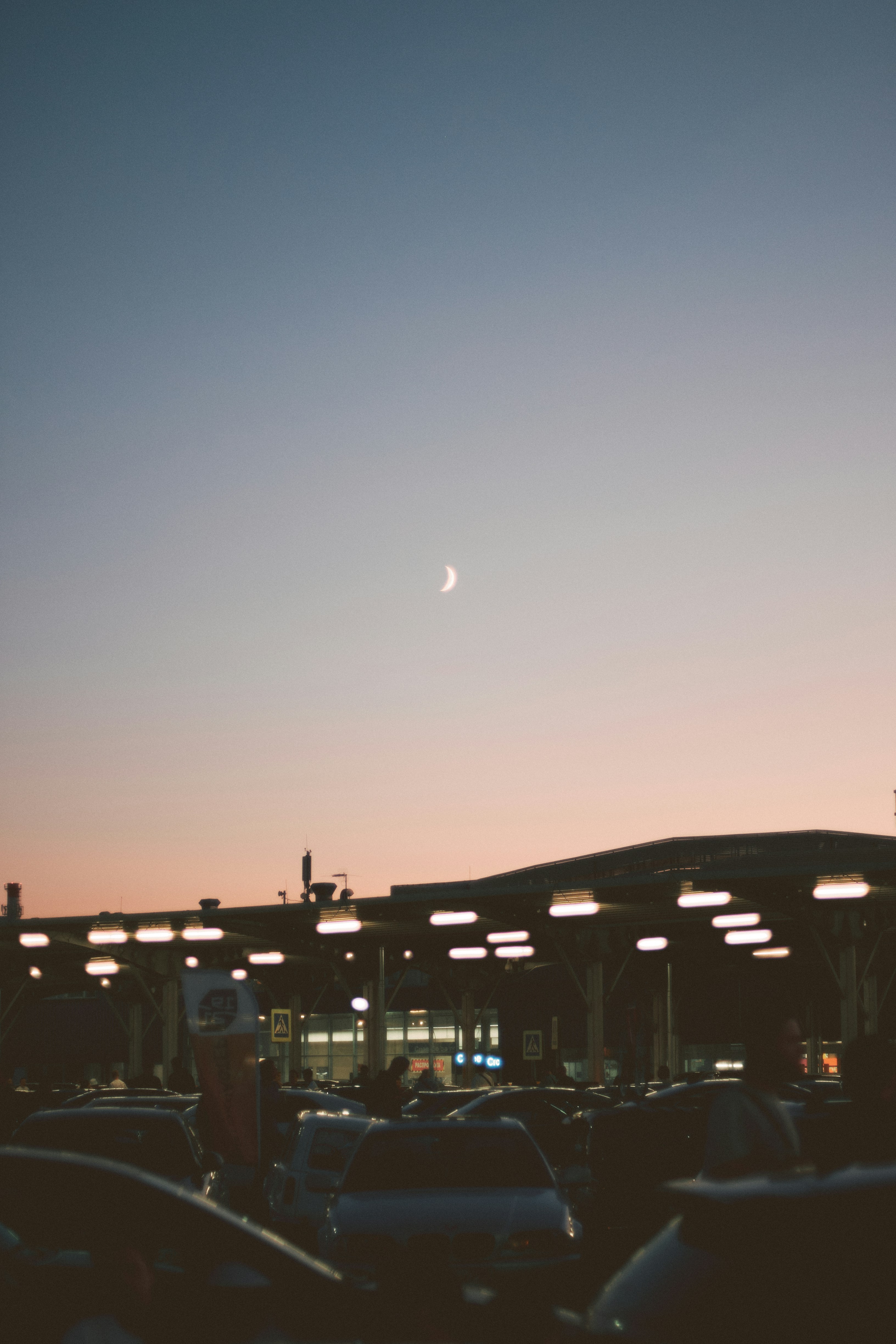 Crescent Moon Over a Dusk-lit Station
