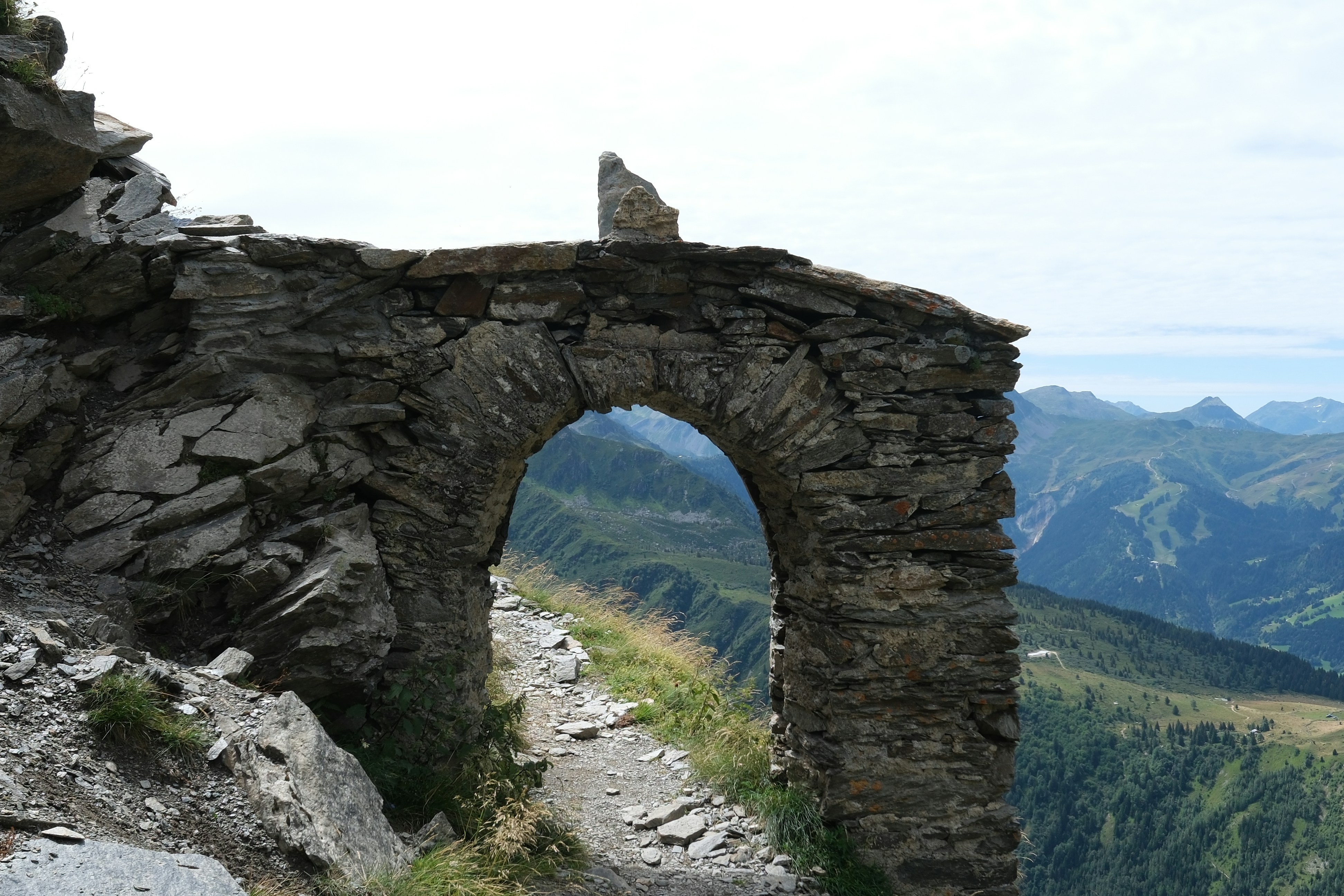 A stone arch on the side of a mountain photo – Free Rock Image on Unsplash