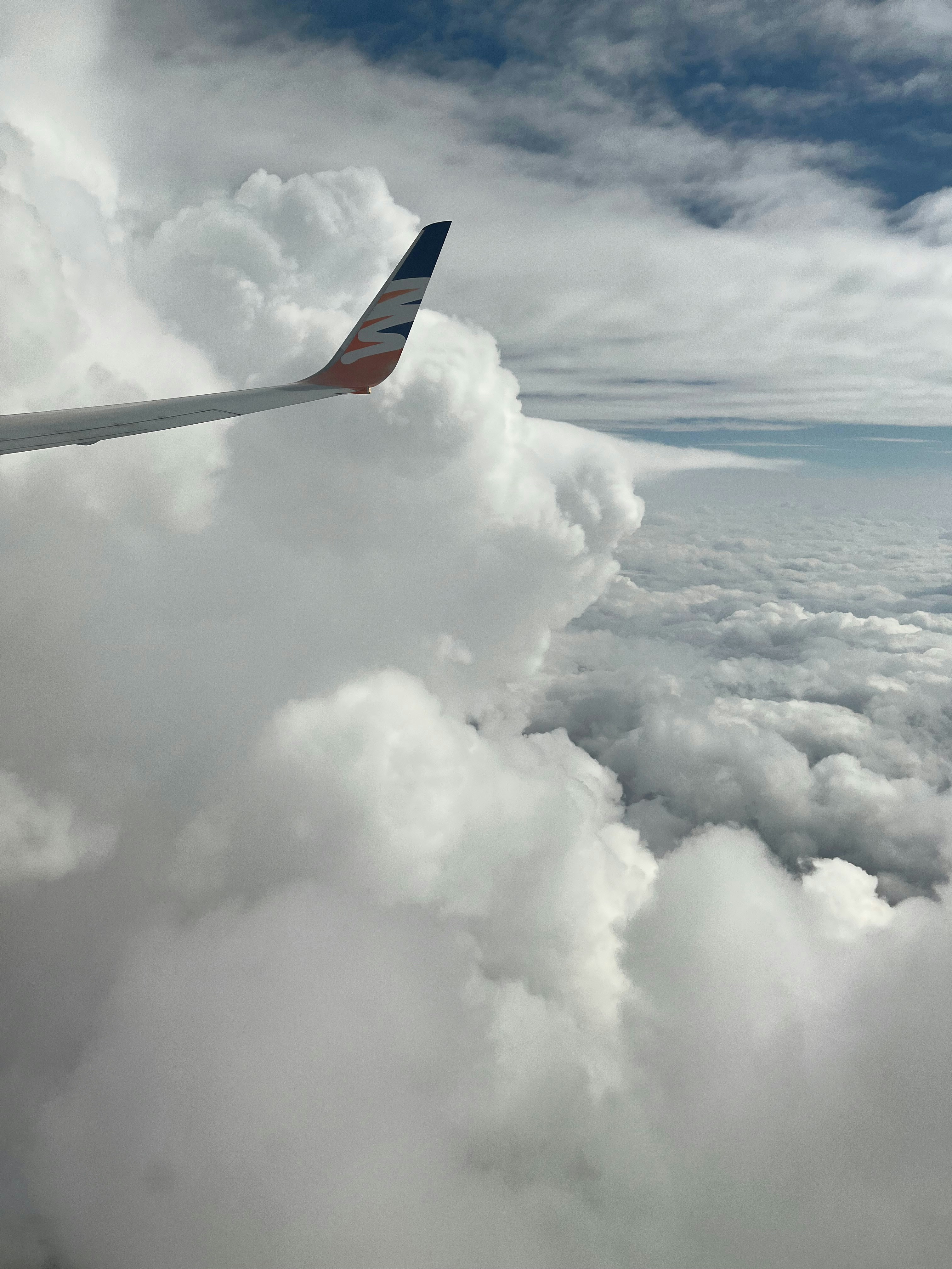 Winglet Above the Clouds: A Quiet Skyward Moment