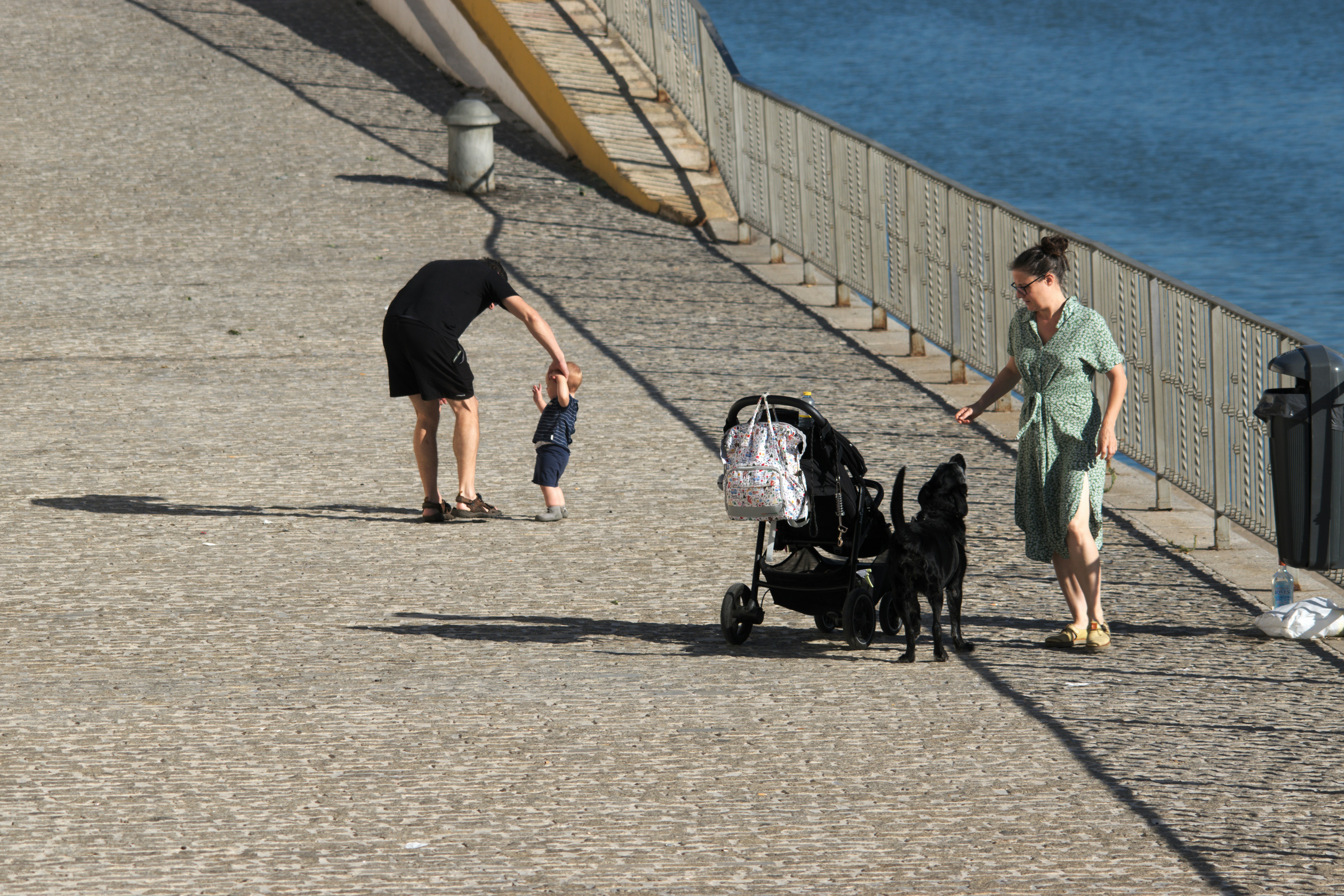 Promenade Pause: A Bend, a Child, and the Waterfront