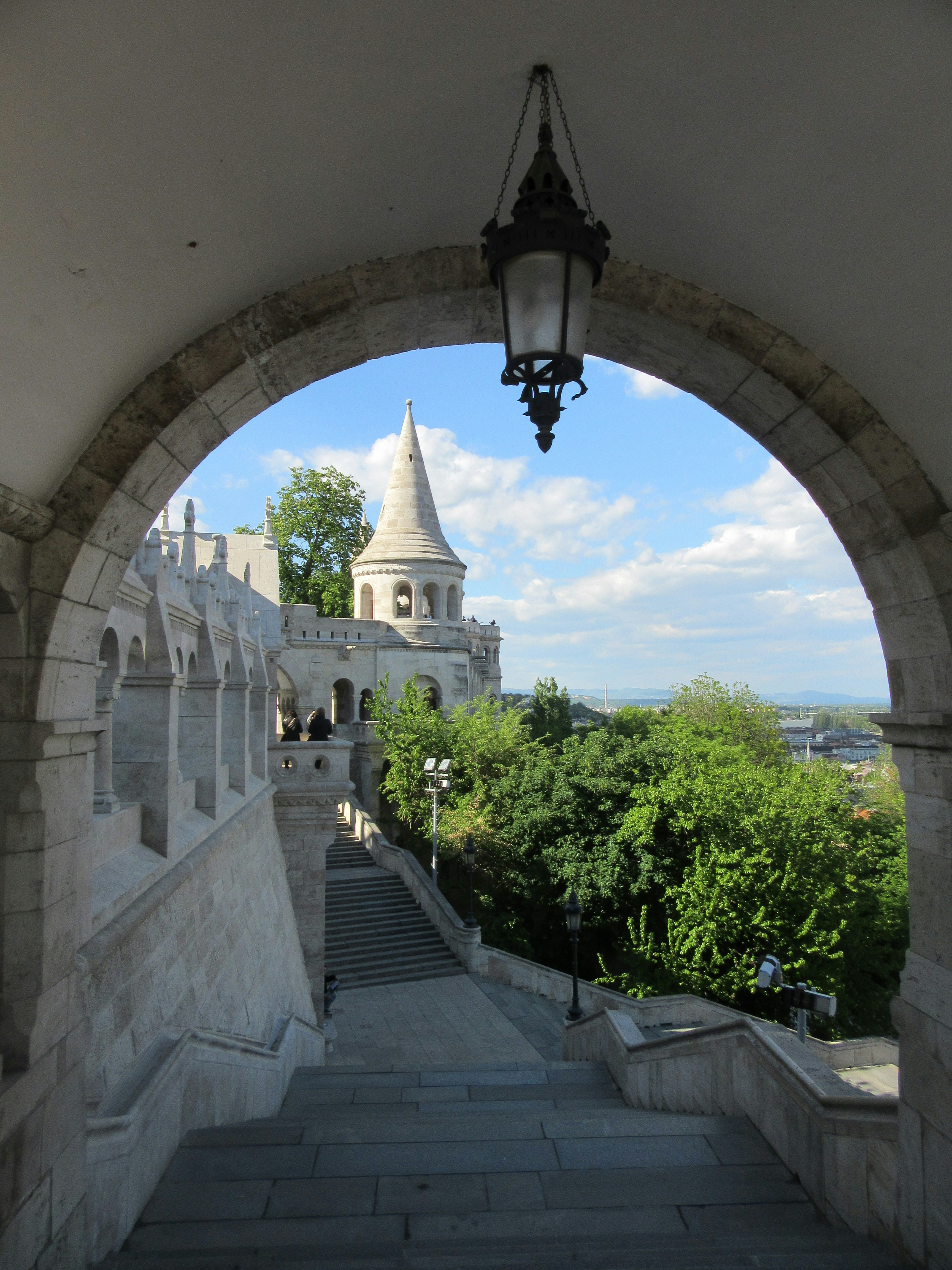 Lantern Arch Framing a Hilltop Fortress Under Blue Skies
