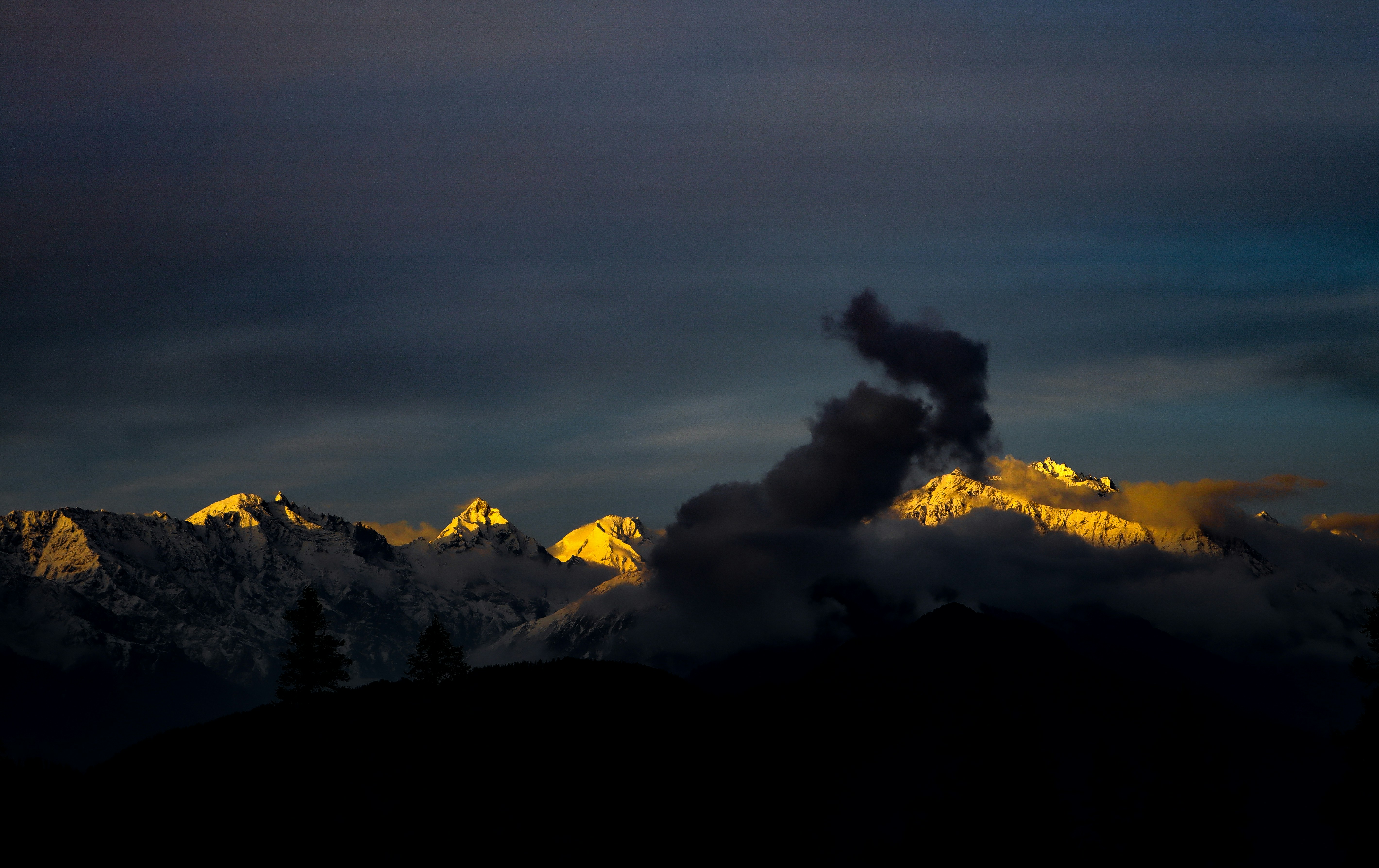 Golden Peaks Shrouded in Night Clouds