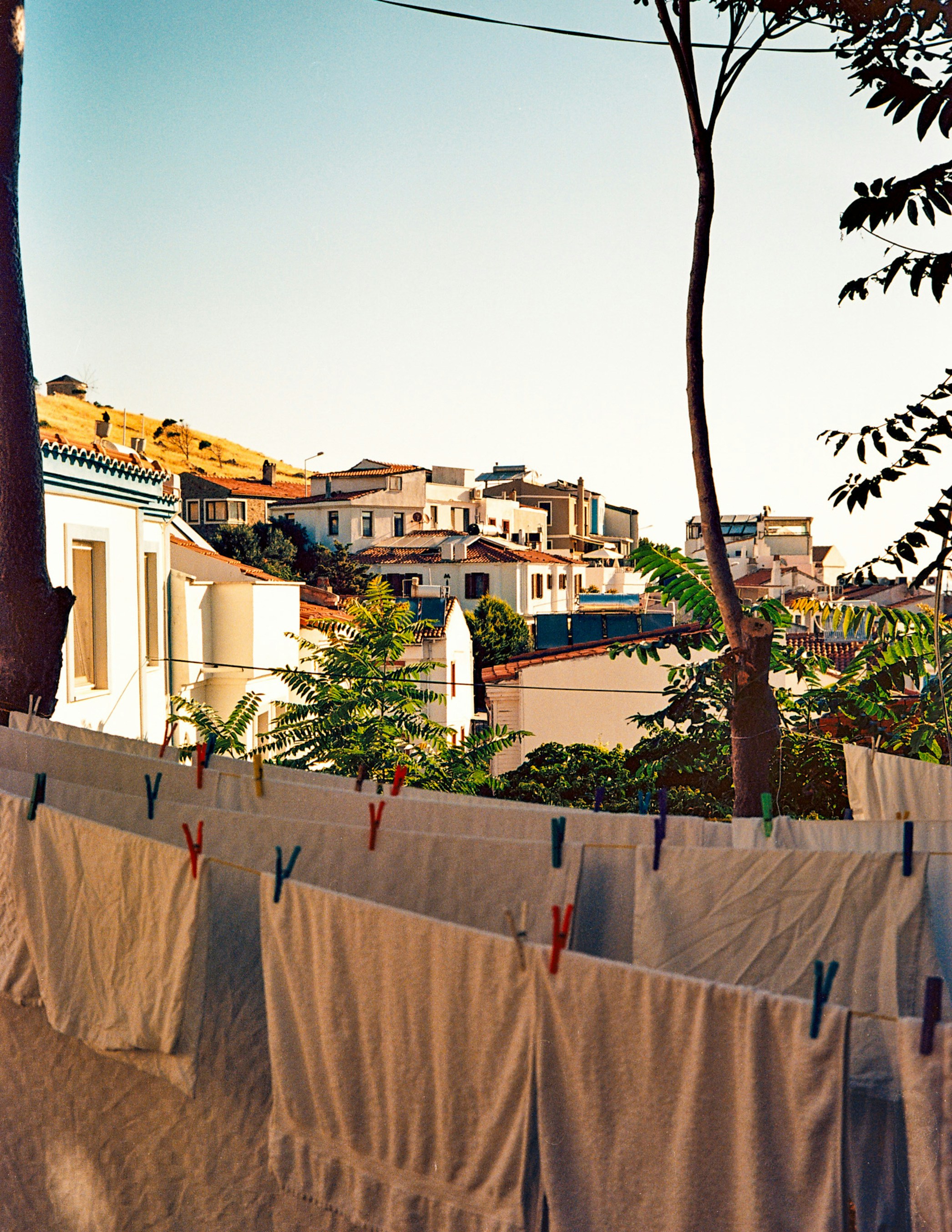 A row of clothes hanging on a clothes line photo – Free Film ...
