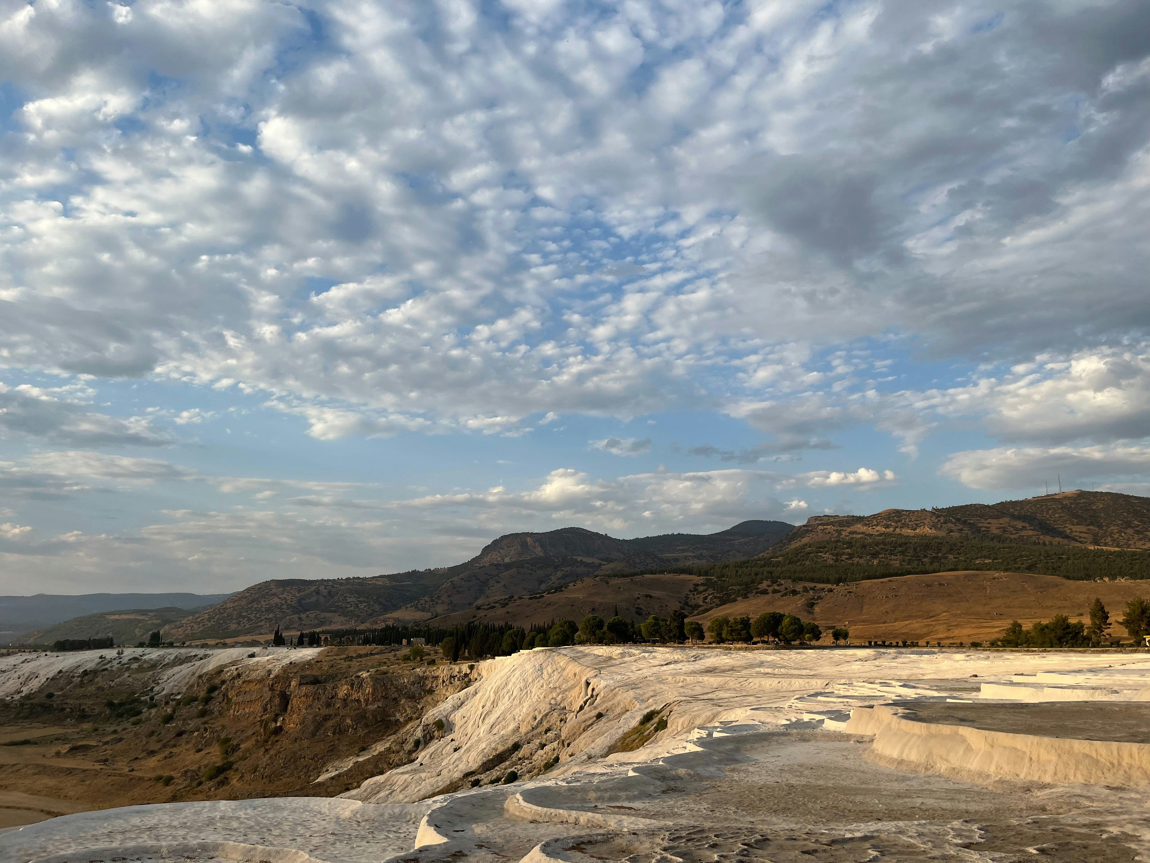 White Travertine Terraces Under a Cloud-Lace Sky