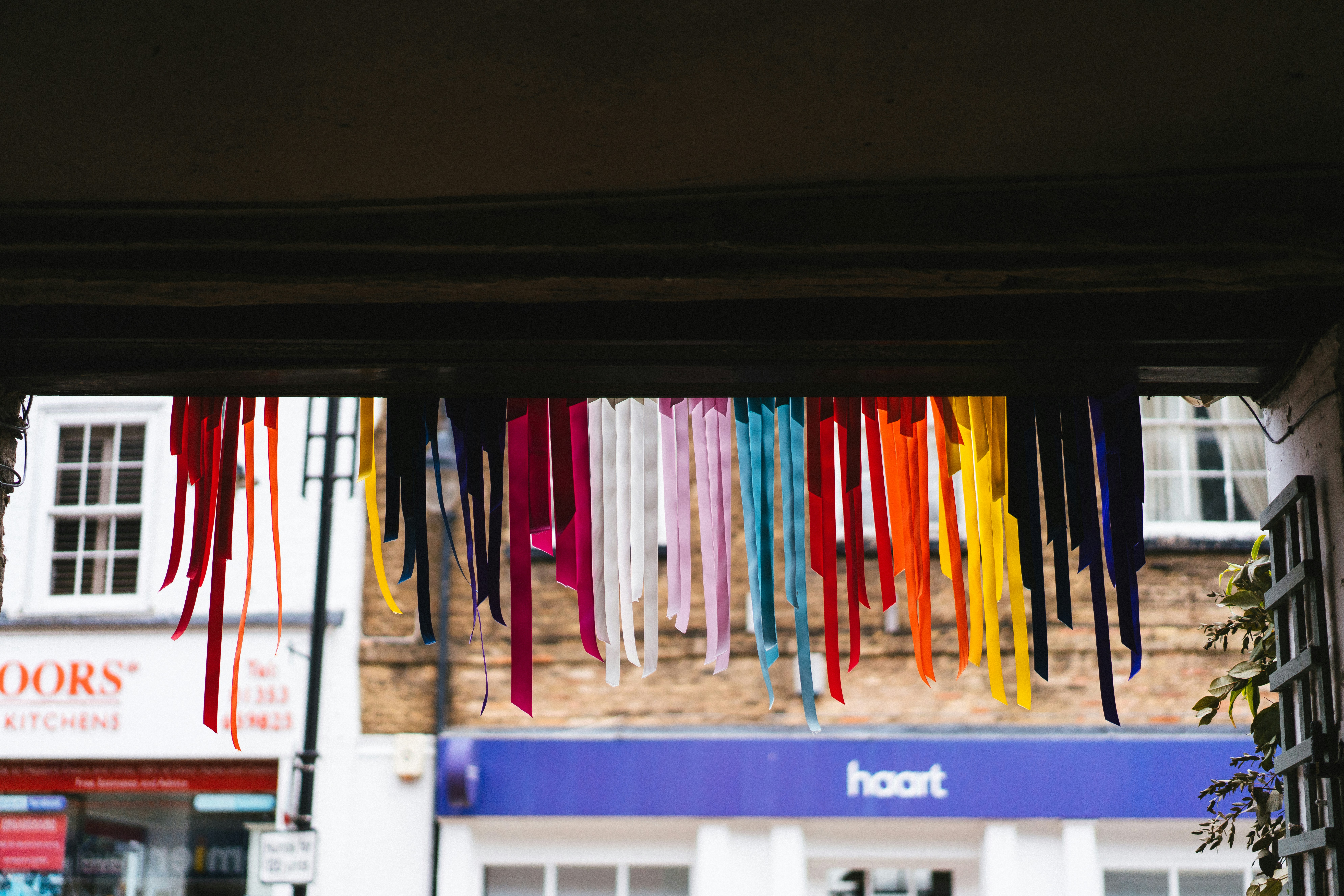 A building with a bunch of colorful streamers hanging from it's side ...