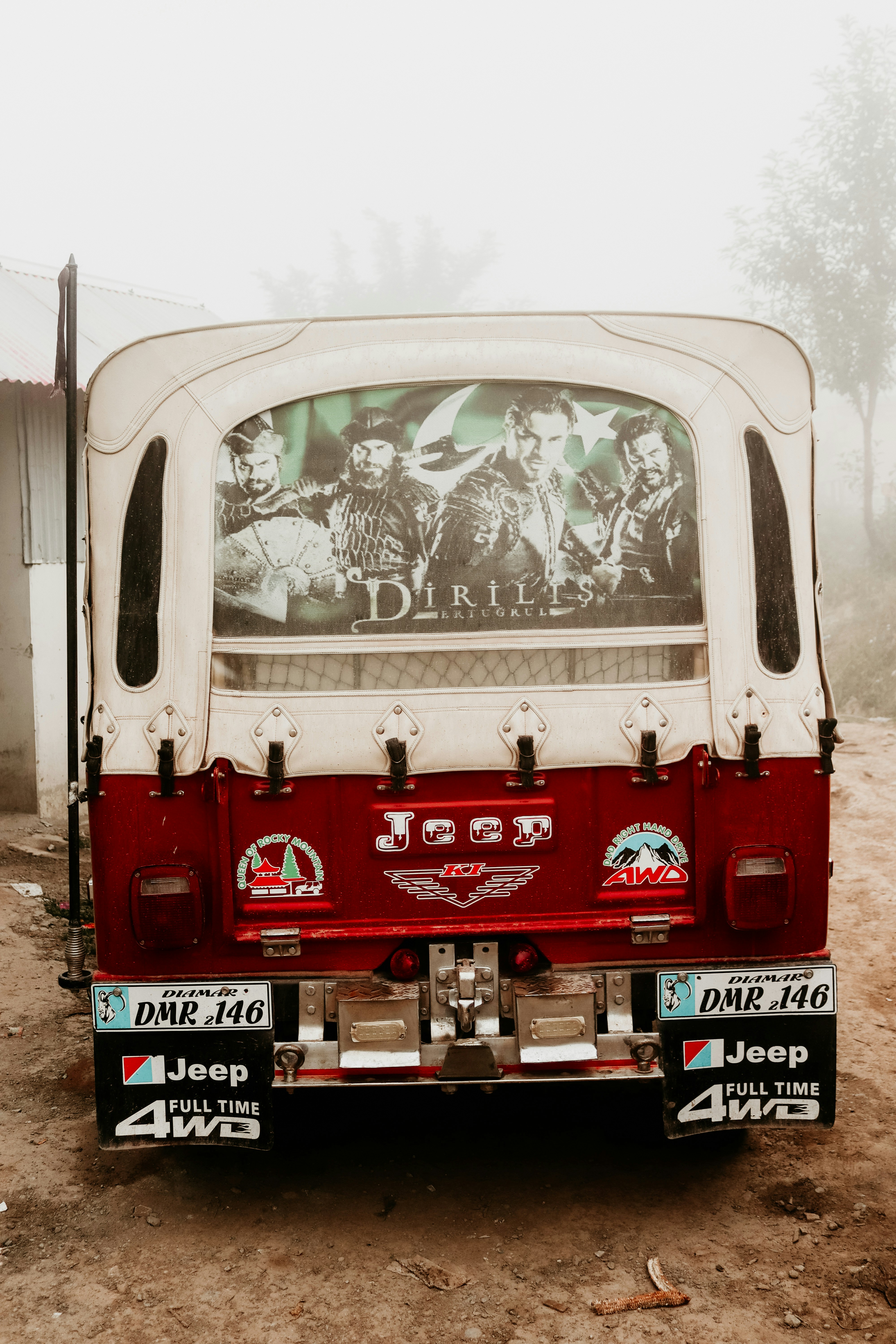 Rear Portrait of a Decorated Jeep in a Dusty Landscape