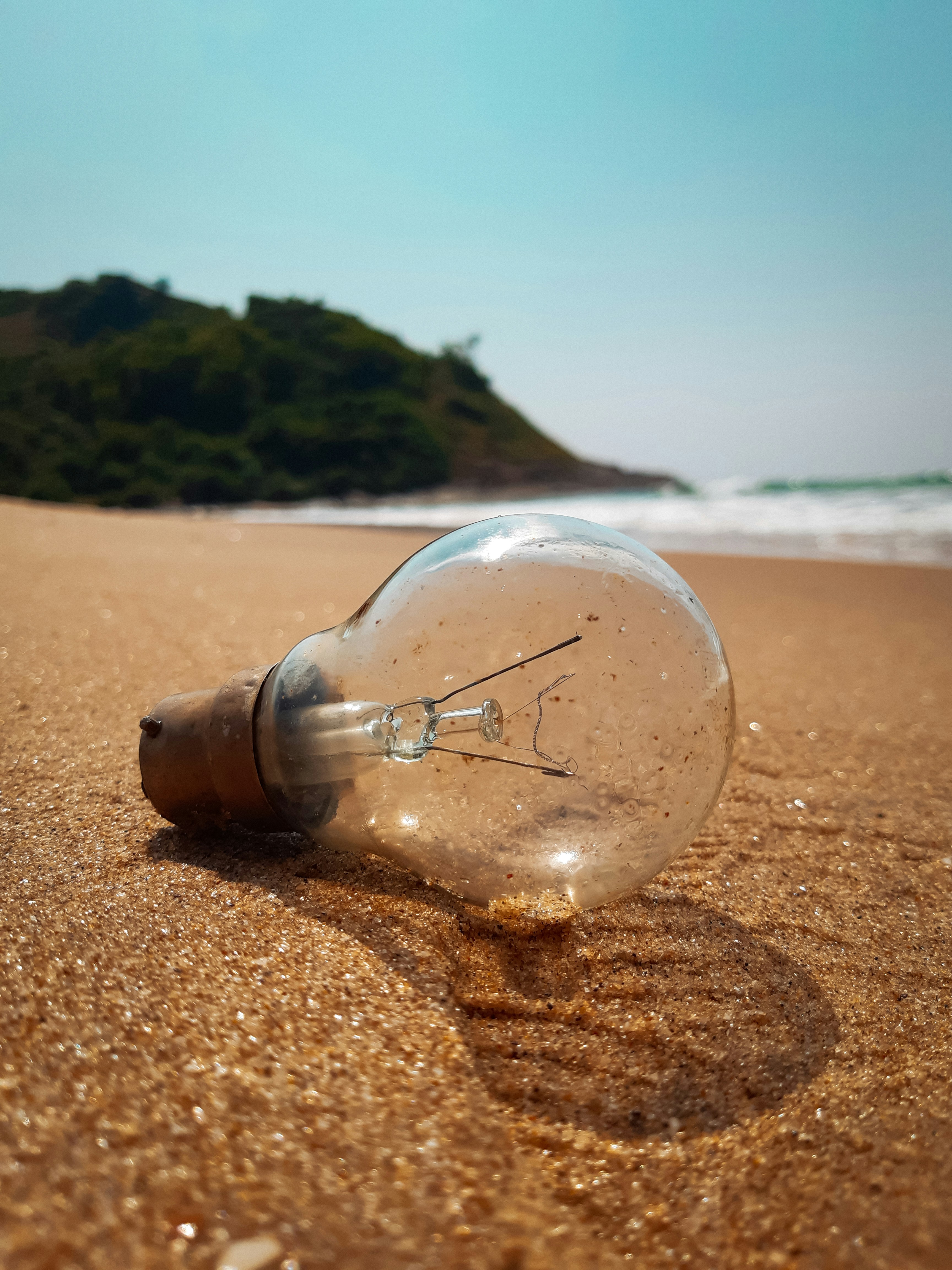 Glass Bulb on Sun-Warmed Sand: A Quiet Beach Study