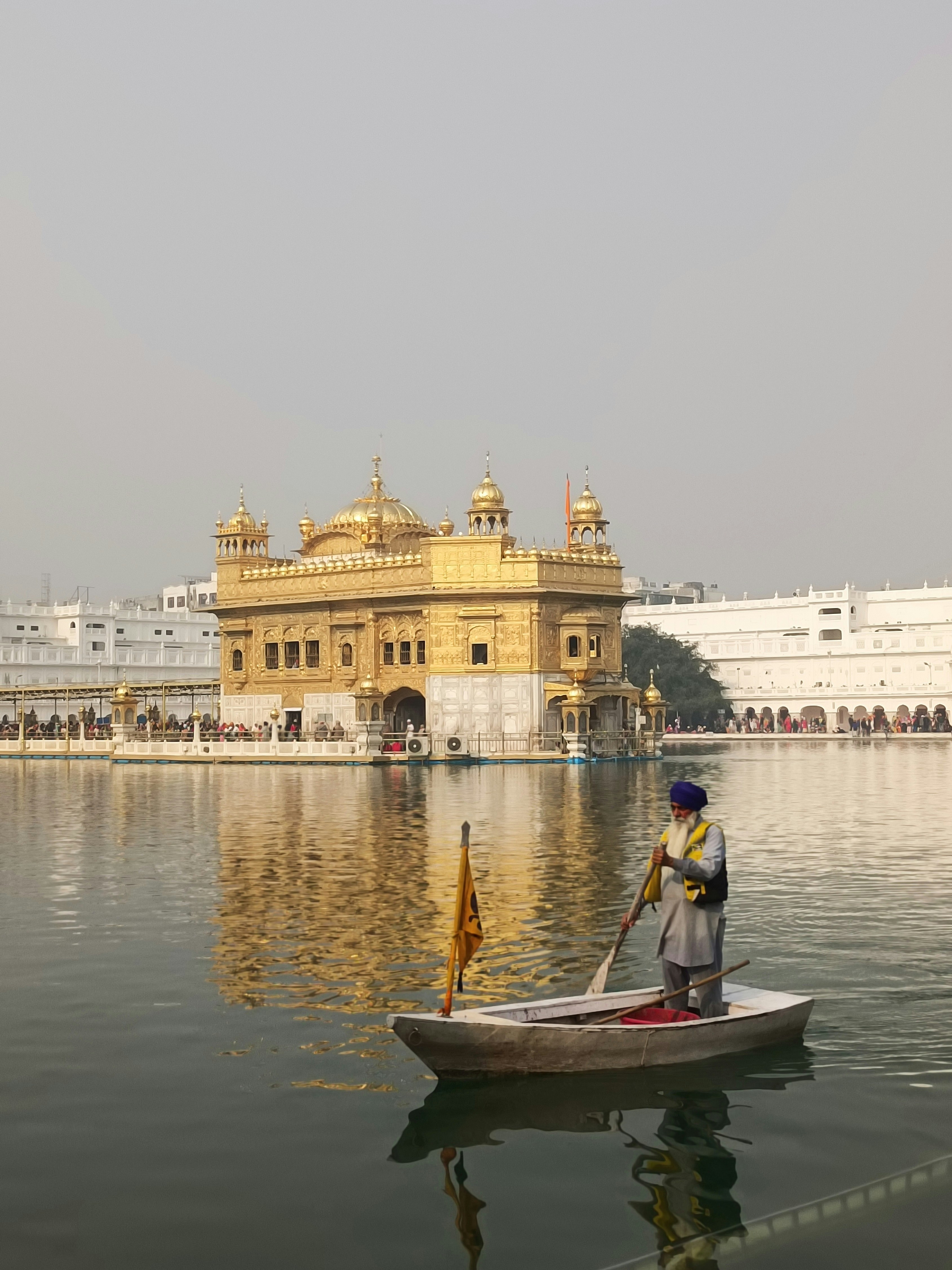 Gold Shimmer Across the Sacred Pool: Temple and Boat in Amritsar