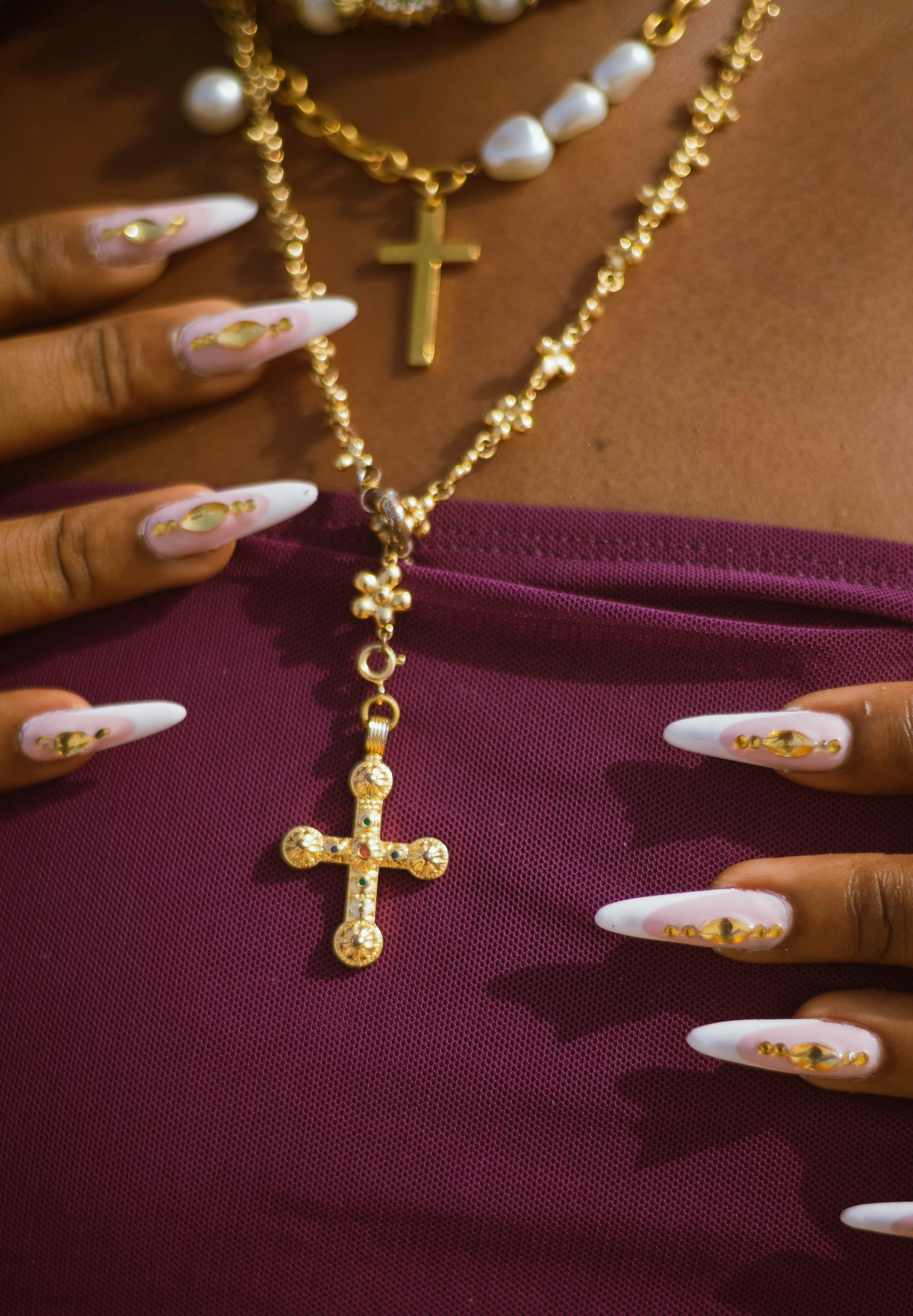 Crosses on Velvet: A Close-Up Portrait of Jewelry and Nail Art