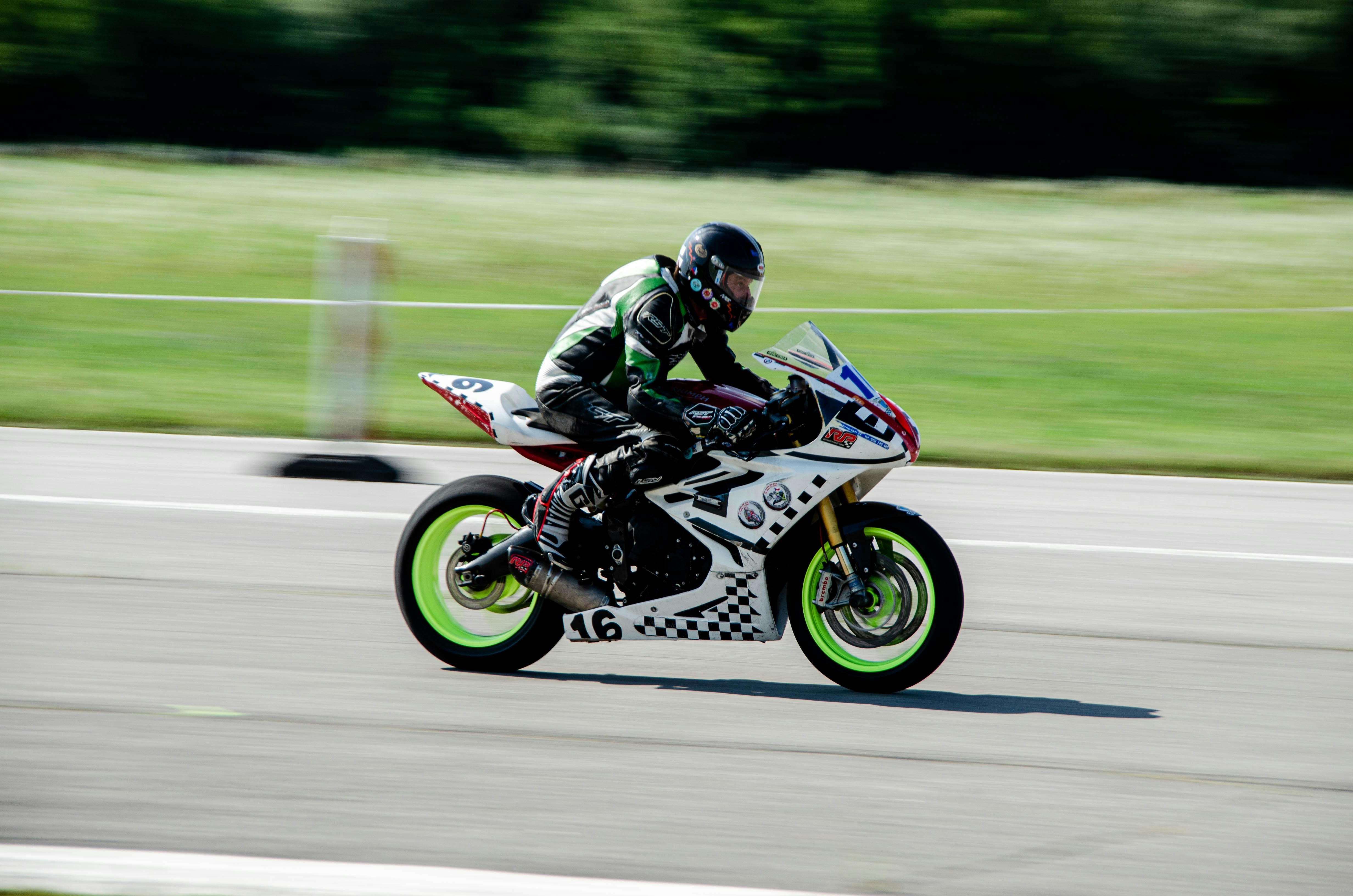 A man riding a motorcycle down a curvy road photo – Free Ducati Image ...