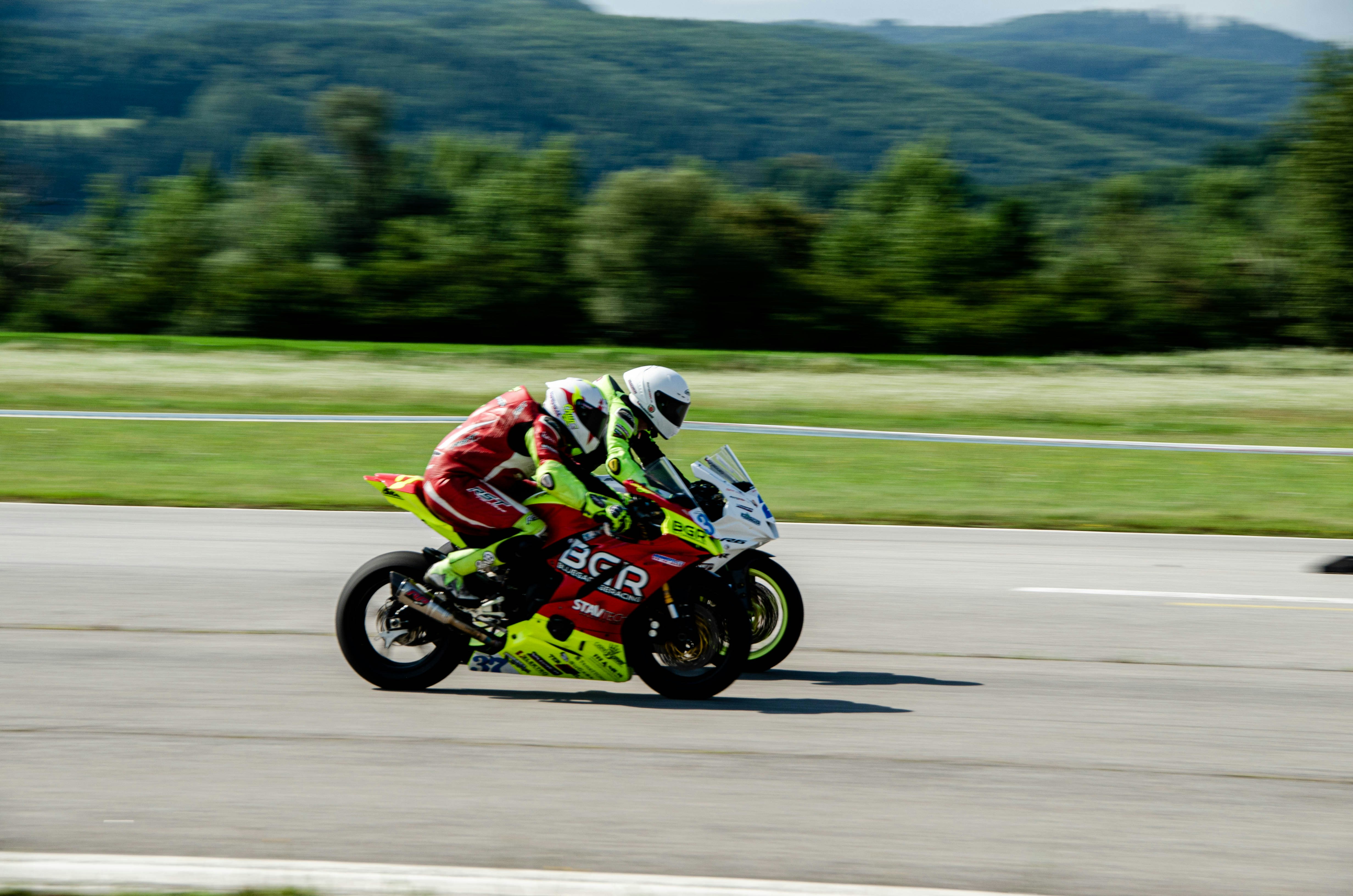 A man riding a motorcycle down a curvy road photo – Free Ducati Image ...