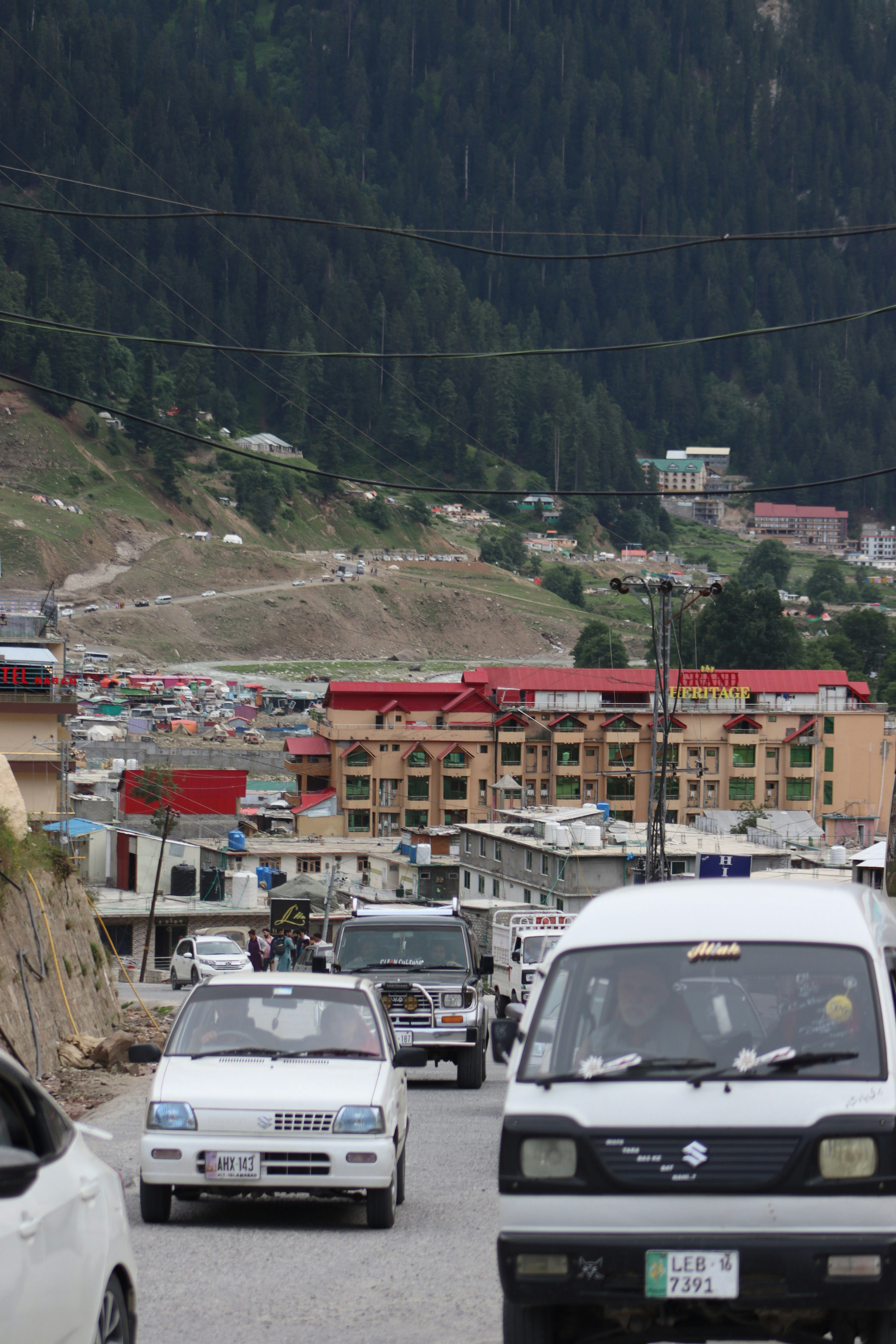 Bustle on the Mountain Road: A Valley Town Fringed by Forested Slopes
